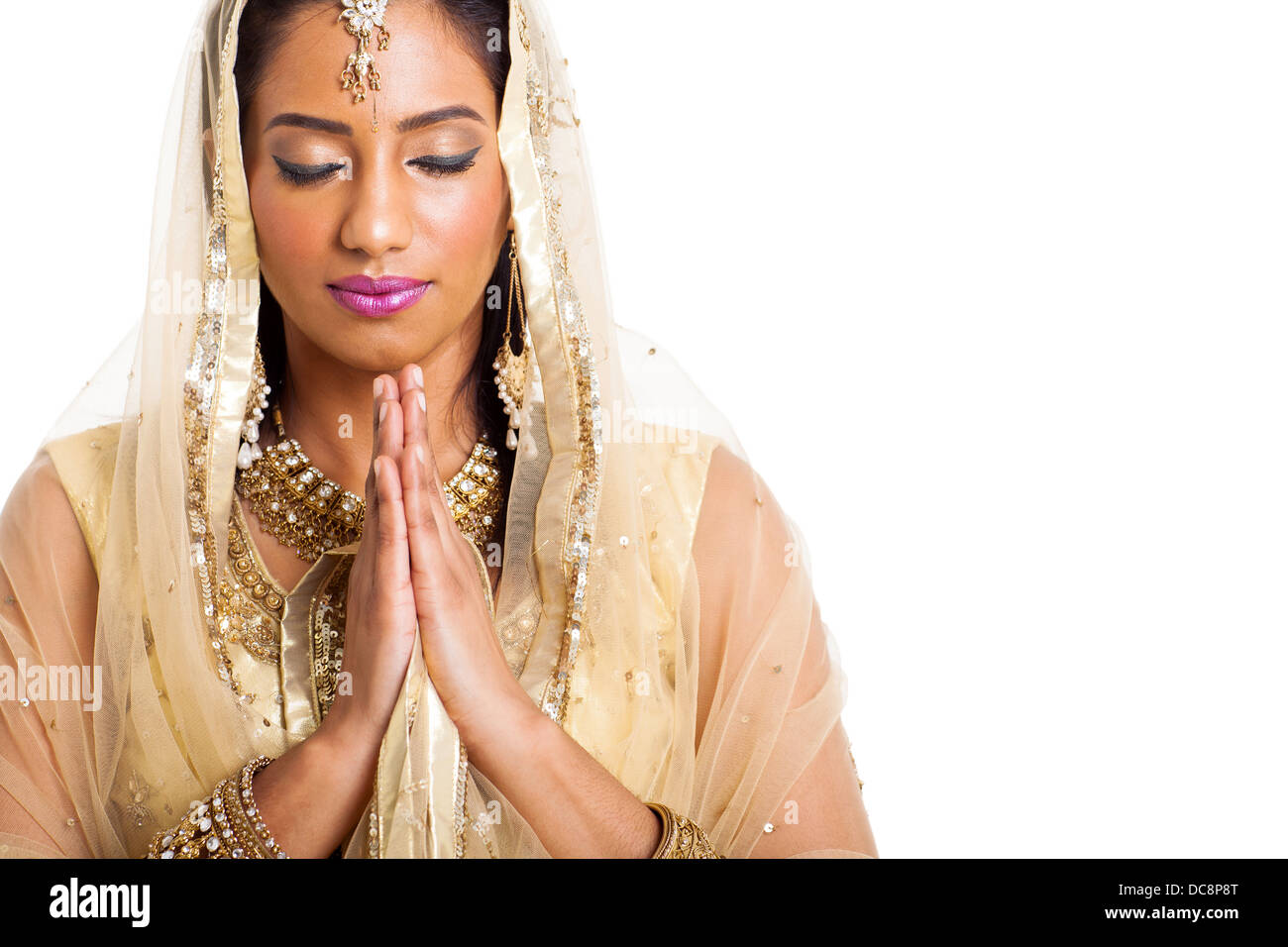 beautiful Indian woman praying with eyes closed on white background ...