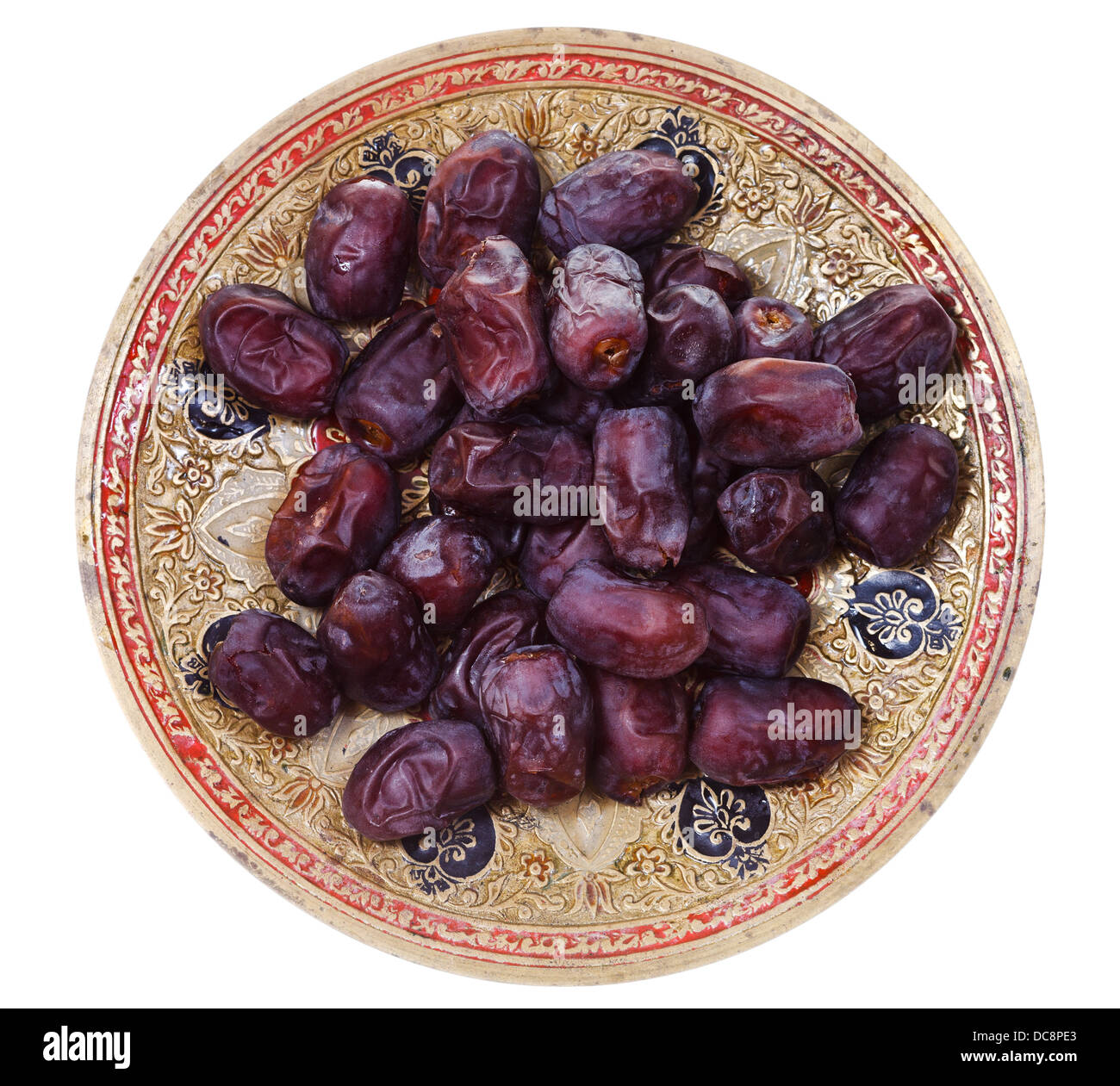 top view of sweet dates on brass indian plate isolated on white ...