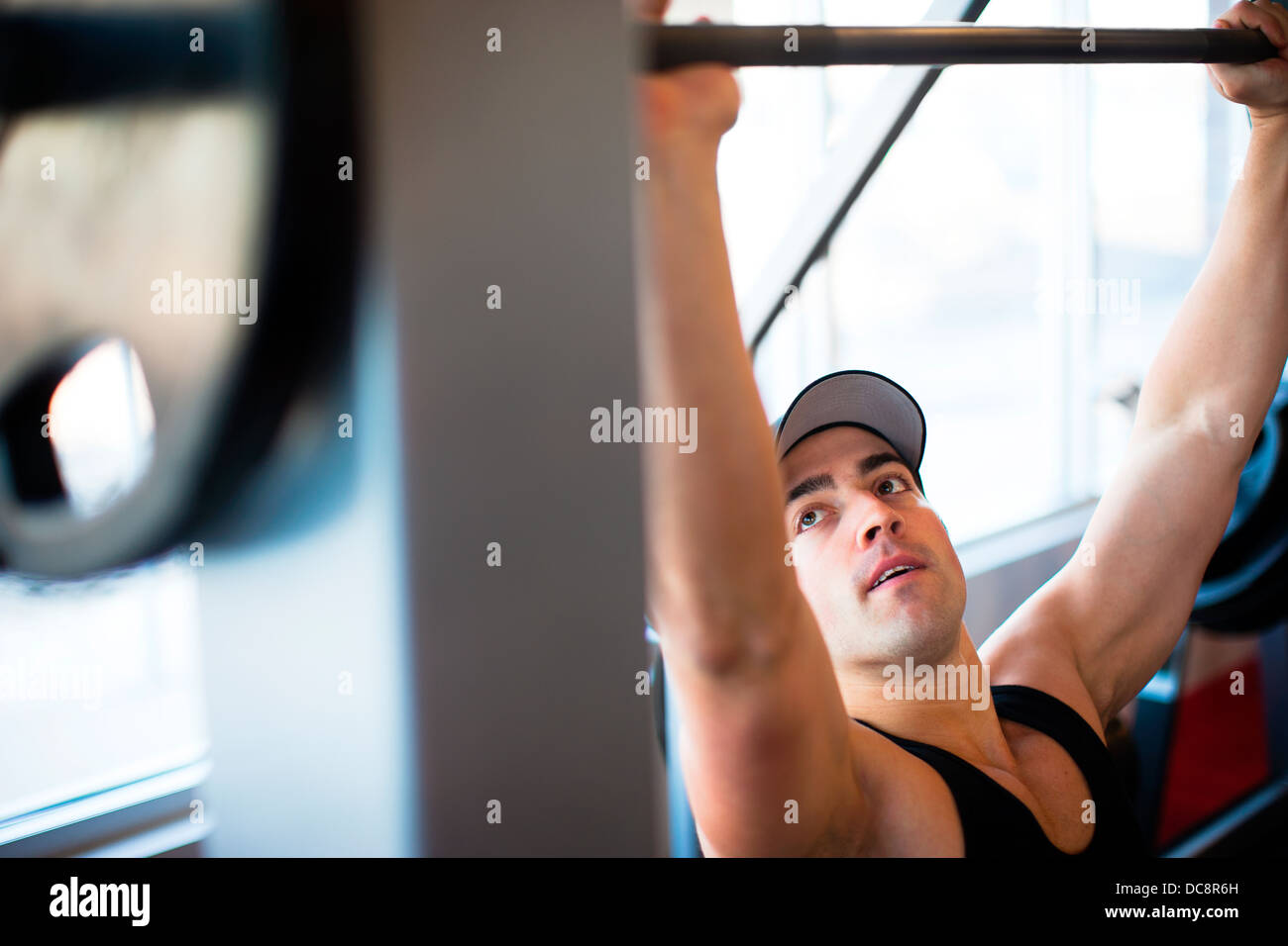a man works out in the gym lifting weights Stock Photo - Alamy