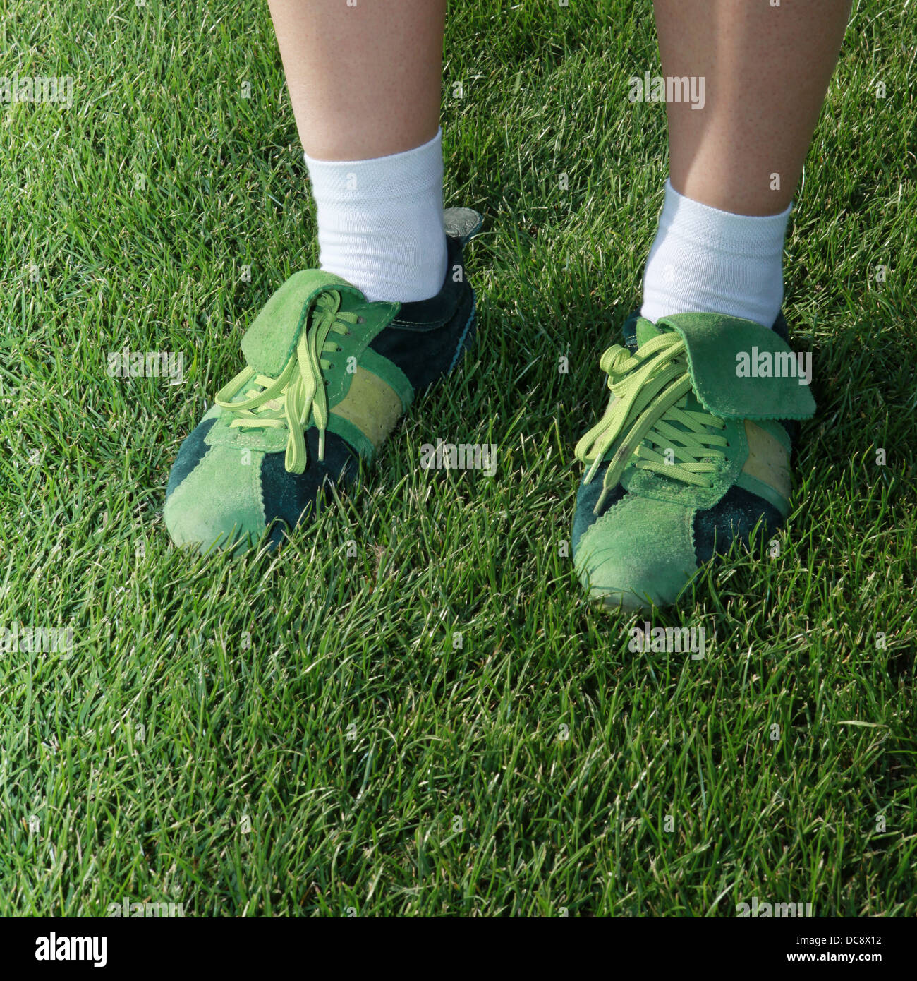 feet of woman dressed in green sports shoes on grass Stock Photo - Alamy