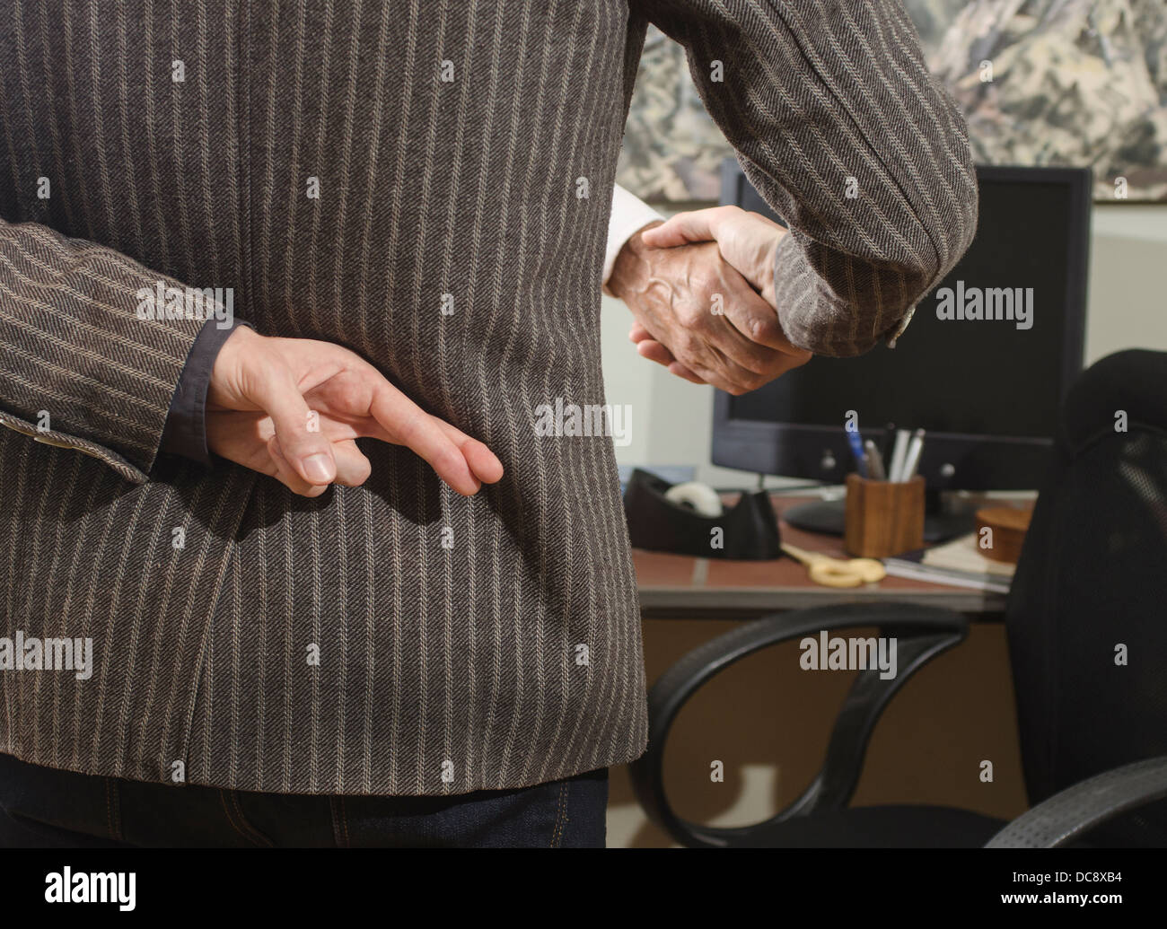 Crossed fingers shaking hands hi-res stock photography and images - Alamy