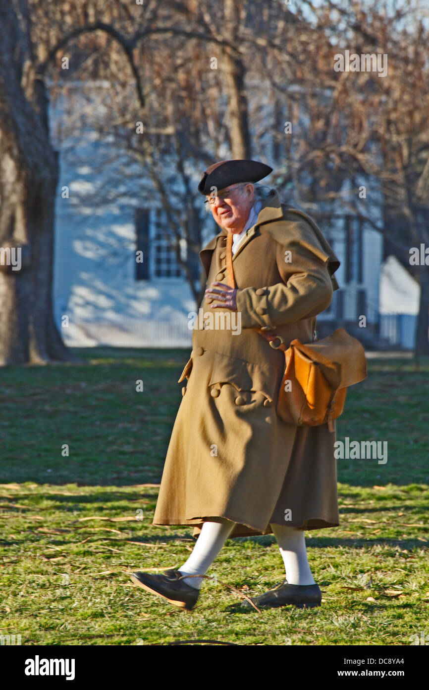 A male interpreter strolling along in Historic Colonial Williamsburg ...