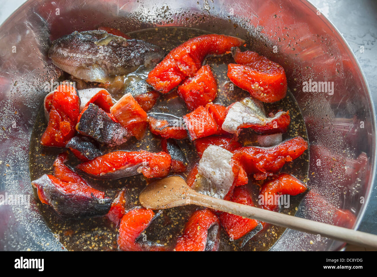 Cooking salmon in a pan; Anchorage, Alaska, United States of America ...