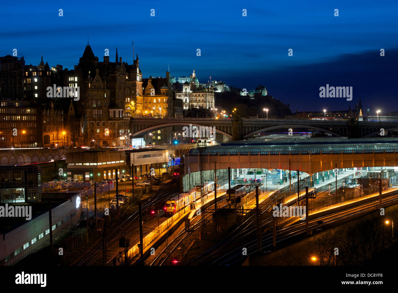 Edinburgh Waverley railway station and the old town at dusk Stock Photo ...