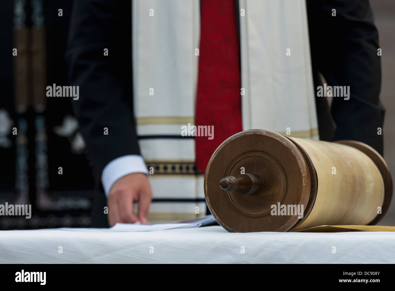A scroll and a man standing behind a table wearing a robe; Beijing ...