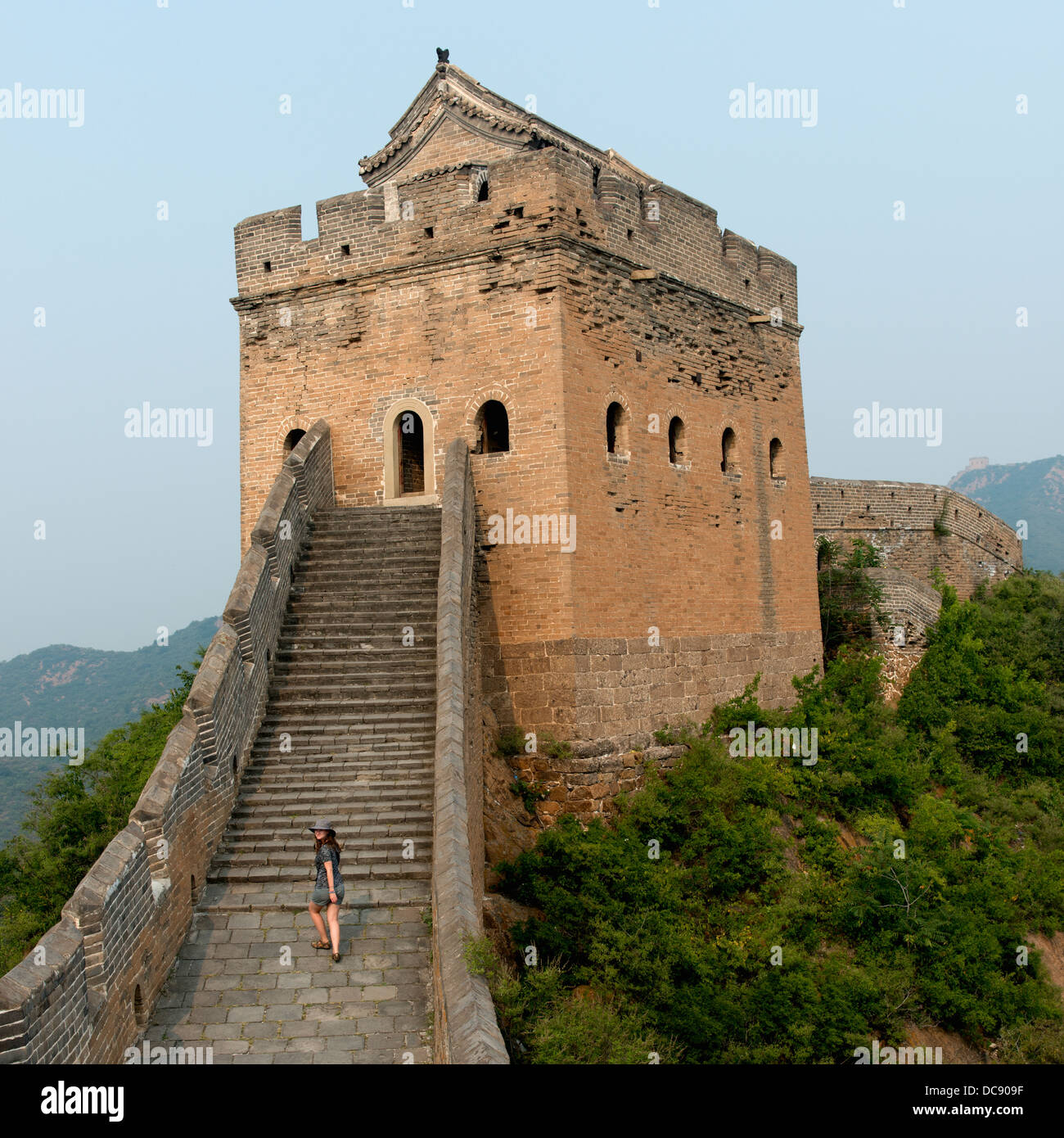 A tourist walking up the steps on the Great Wall of China; Beijing ...