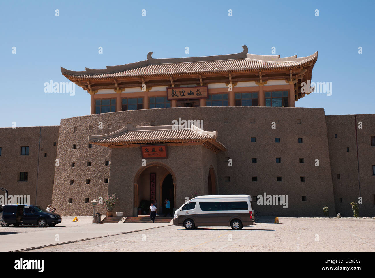 Vehicles parked outside a building of traditional chinese architecture ...