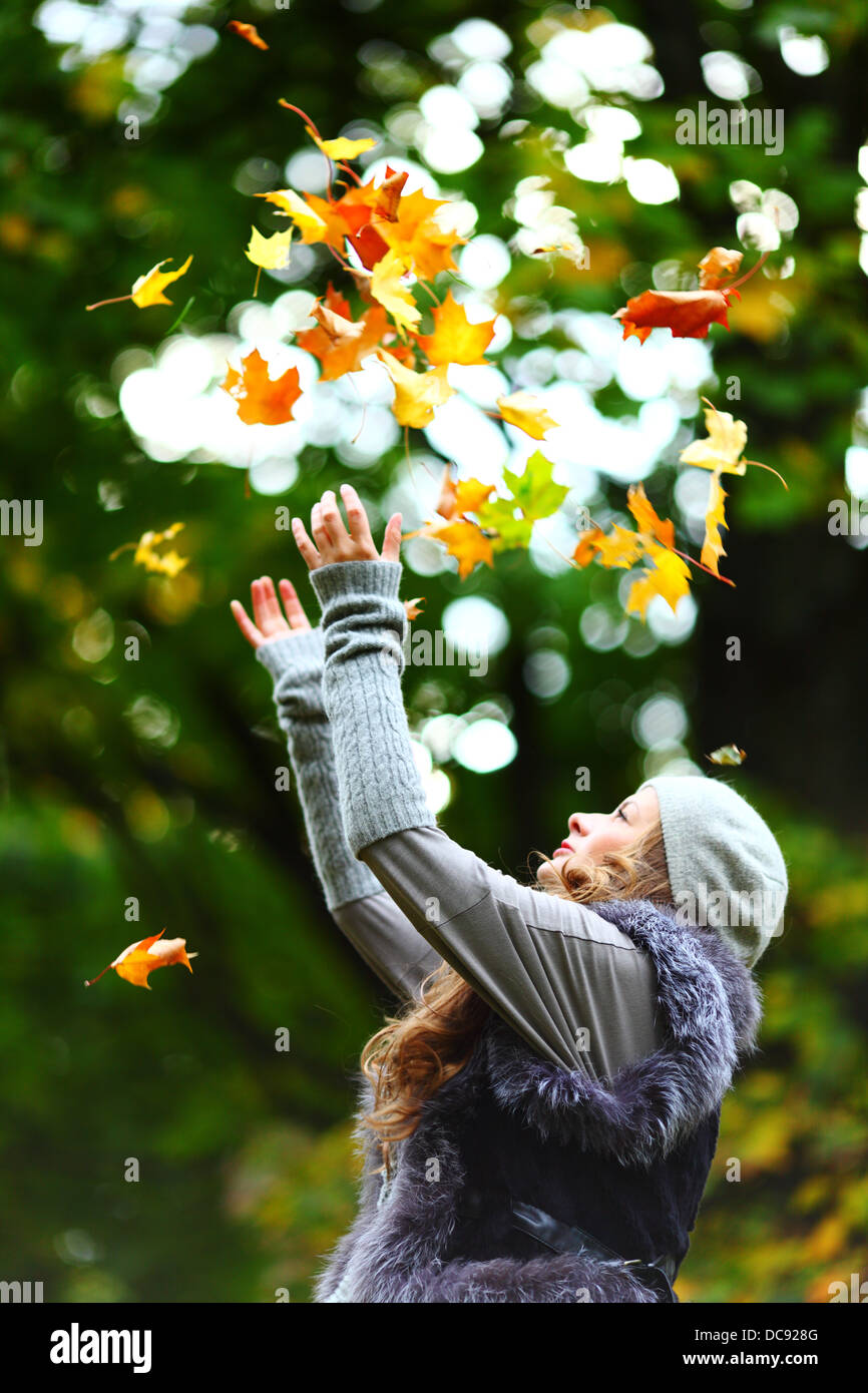 woman drop up leaves in autumn park Stock Photo - Alamy