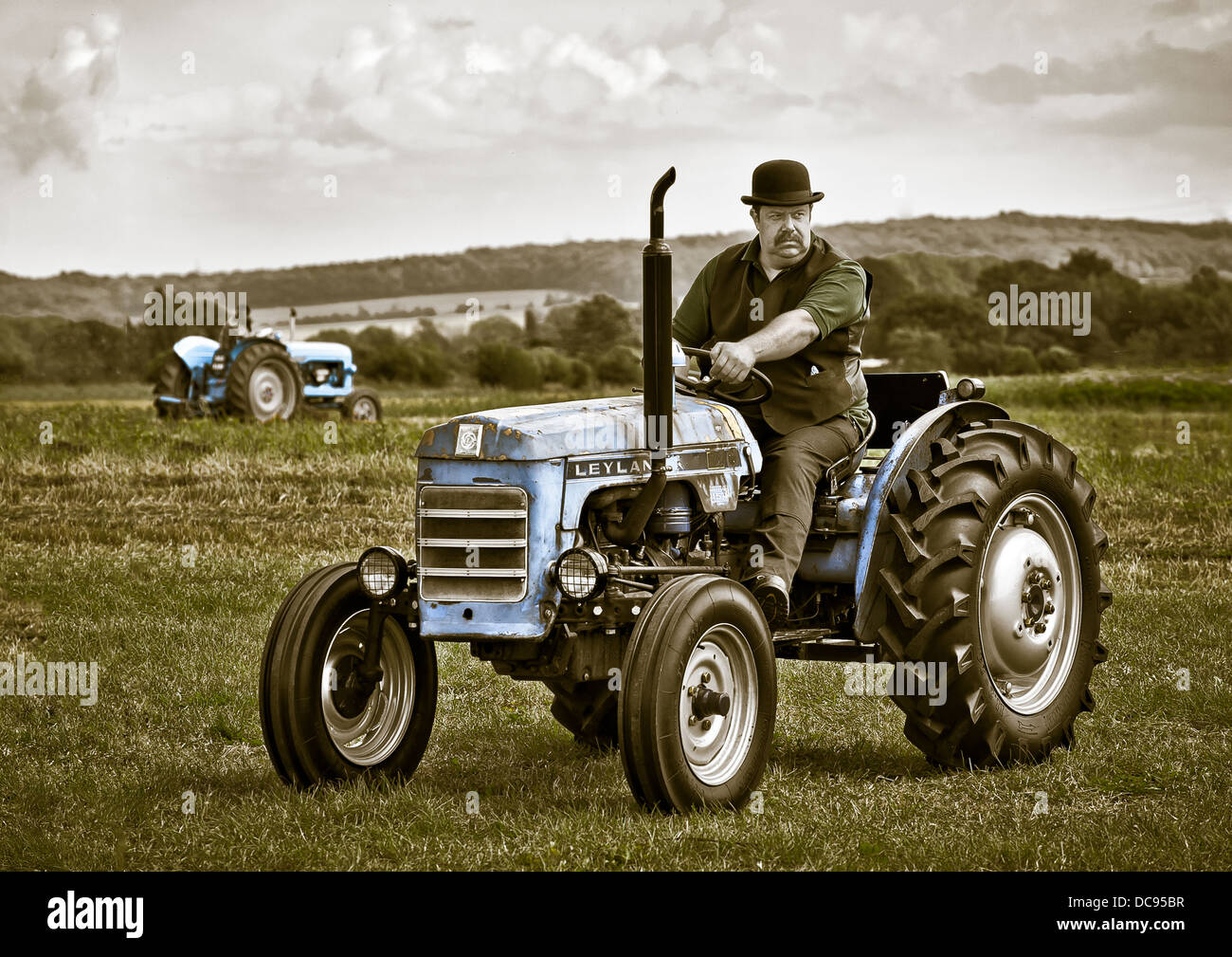 Traditionally dressed man riding tractor Stock Photo - Alamy