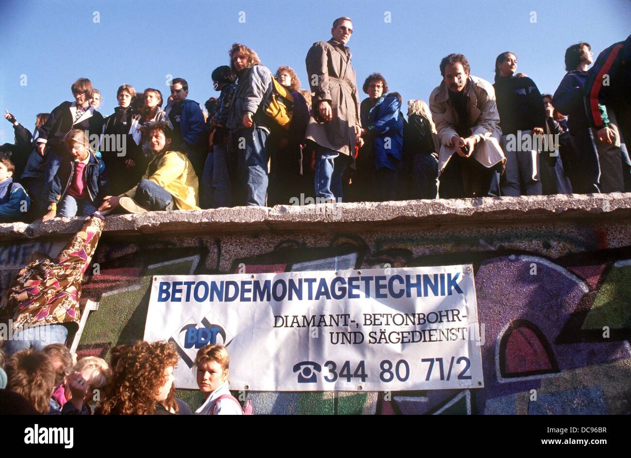 People on top of the Berlin Wall captured in Berlin. After the opening ...