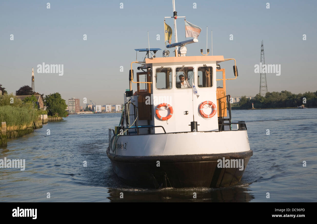 Small passenger ferry waterbus boat crossing River Maas river ...