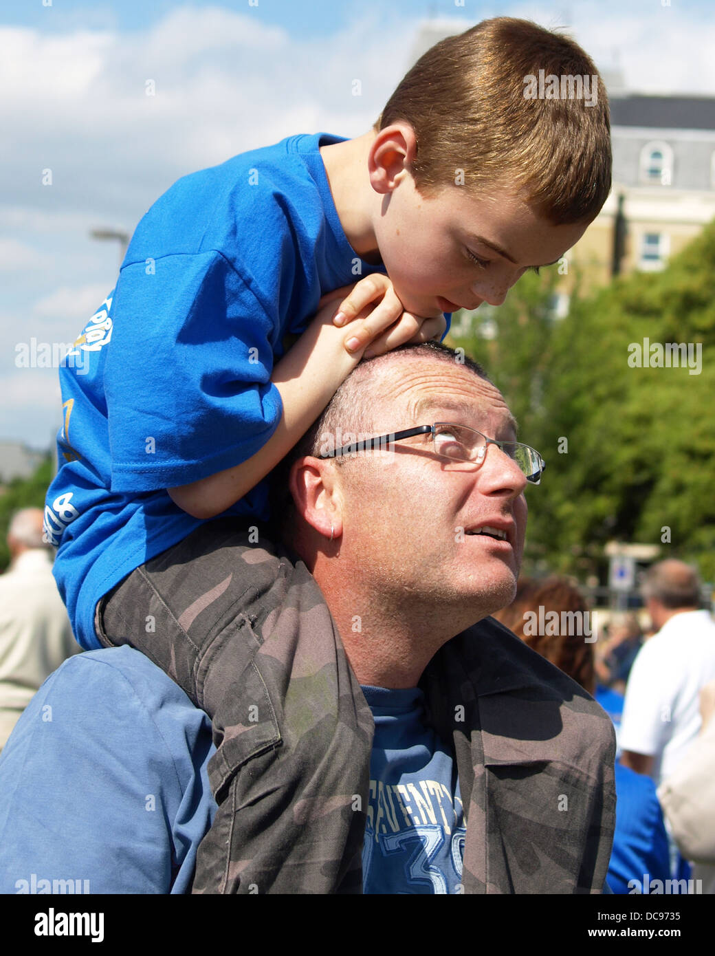 Child riding on dads shoulders hi-res stock photography and images - Alamy