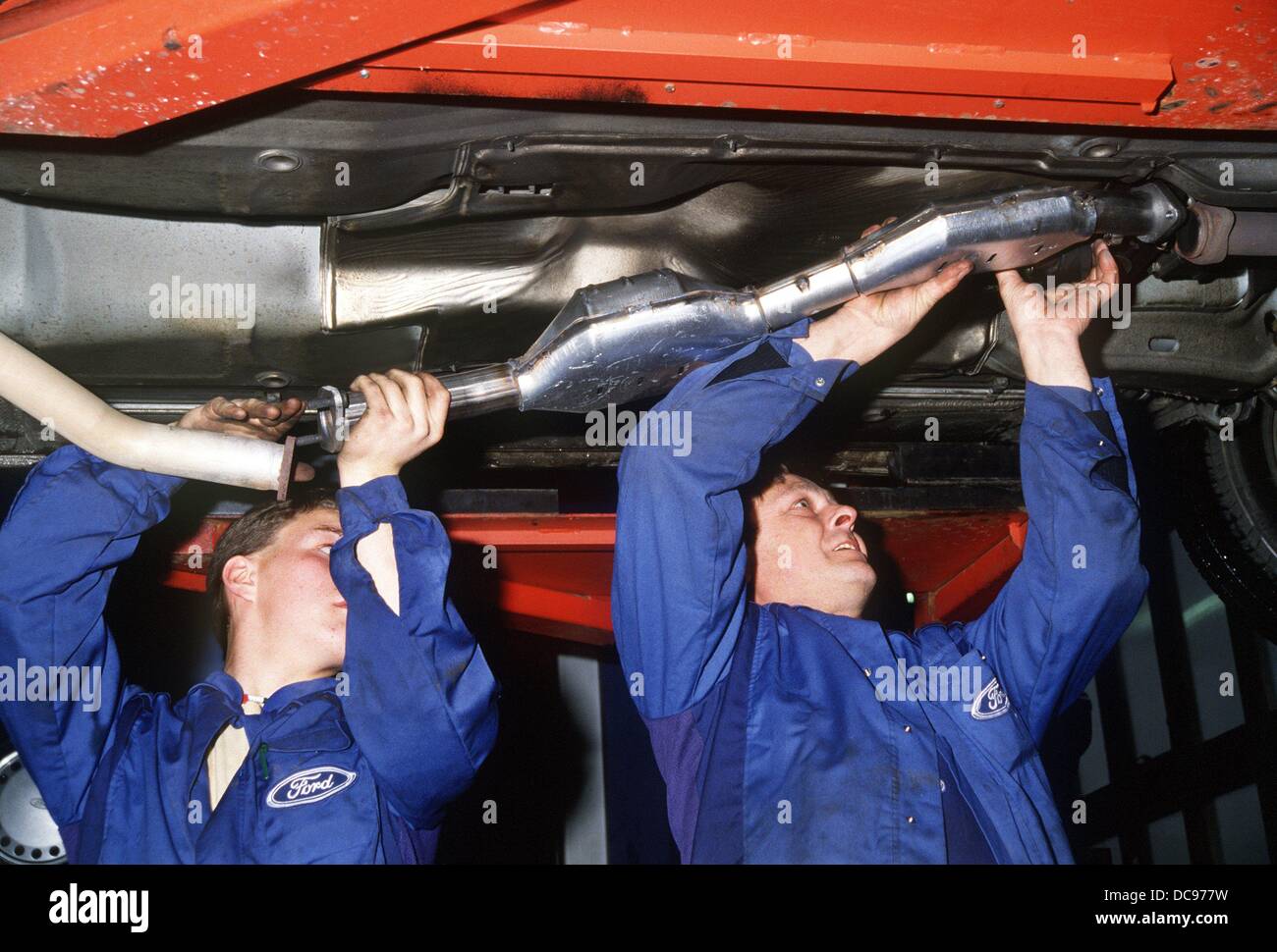 Mechanics incorporate a catalyst into a car in November 1987 Stock ...