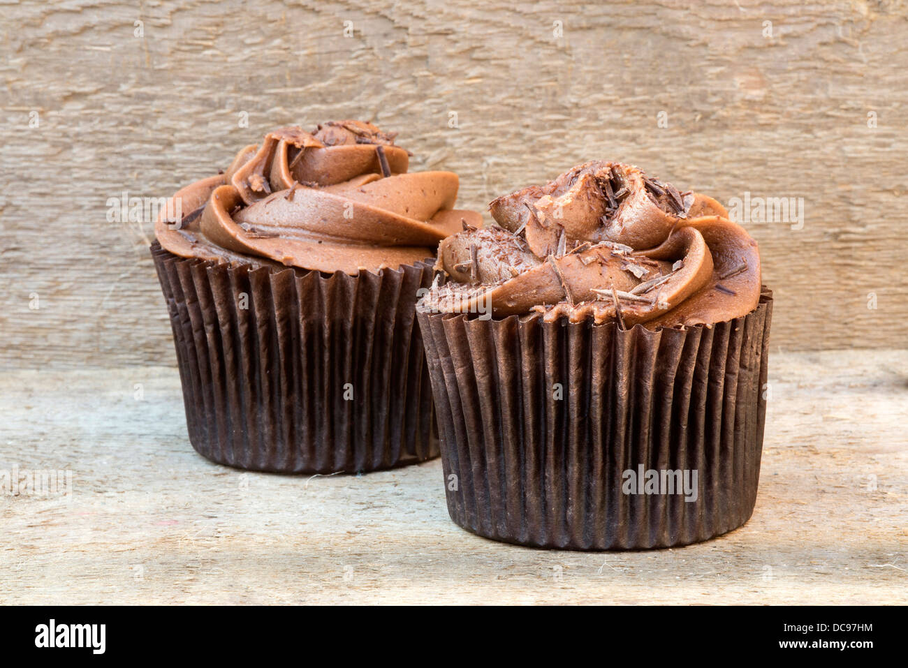 Frosted cupcakes on rustic background Stock Photo - Alamy