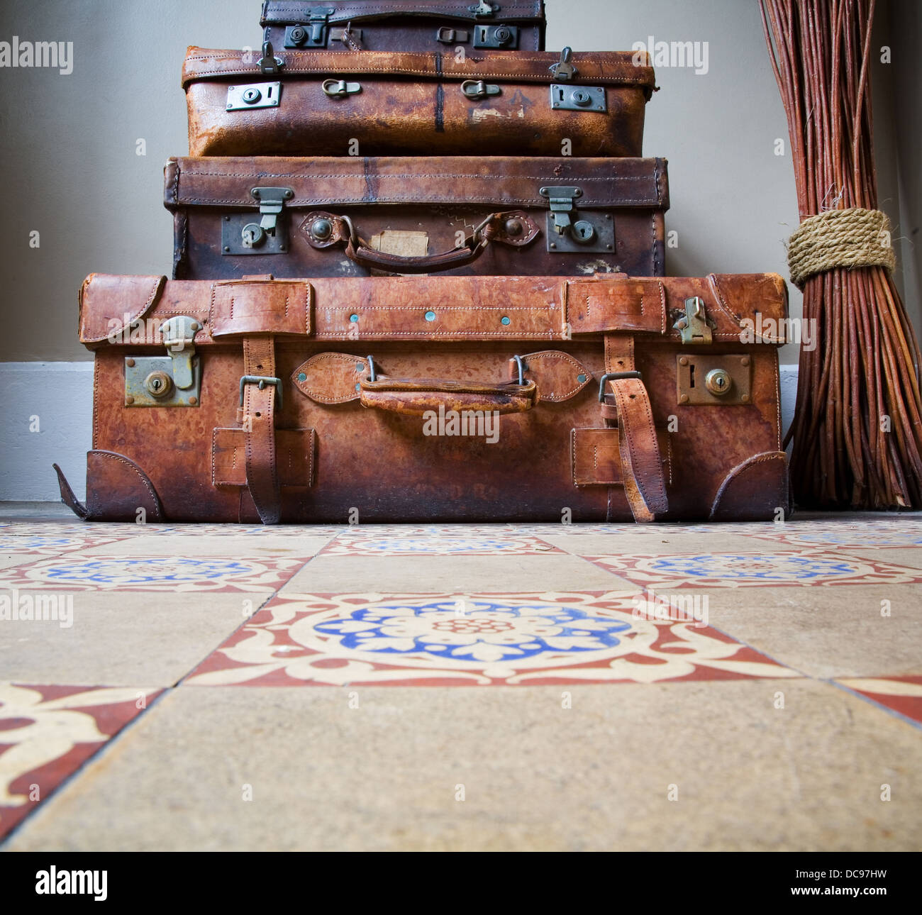 Stack of old leather luggage on tiled floor, copy space on floor Stock ...