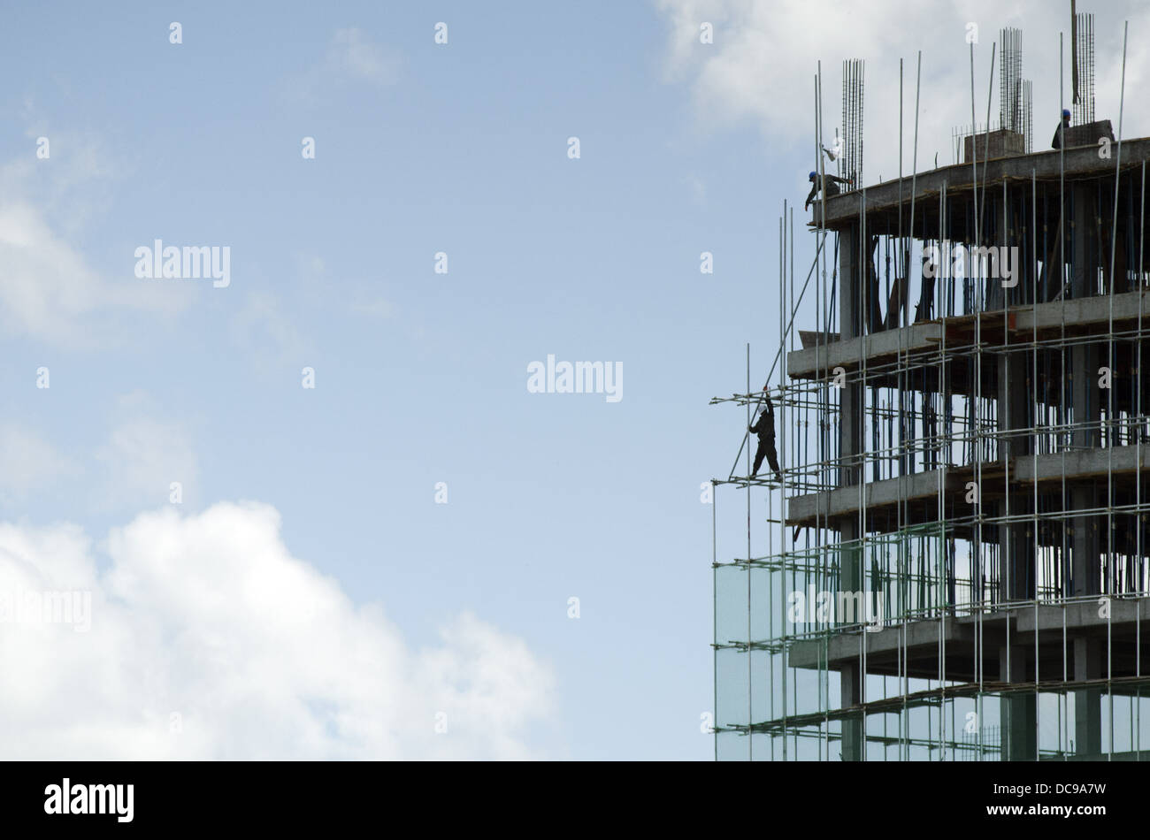 Workers on a high rise construction project of residential and ...