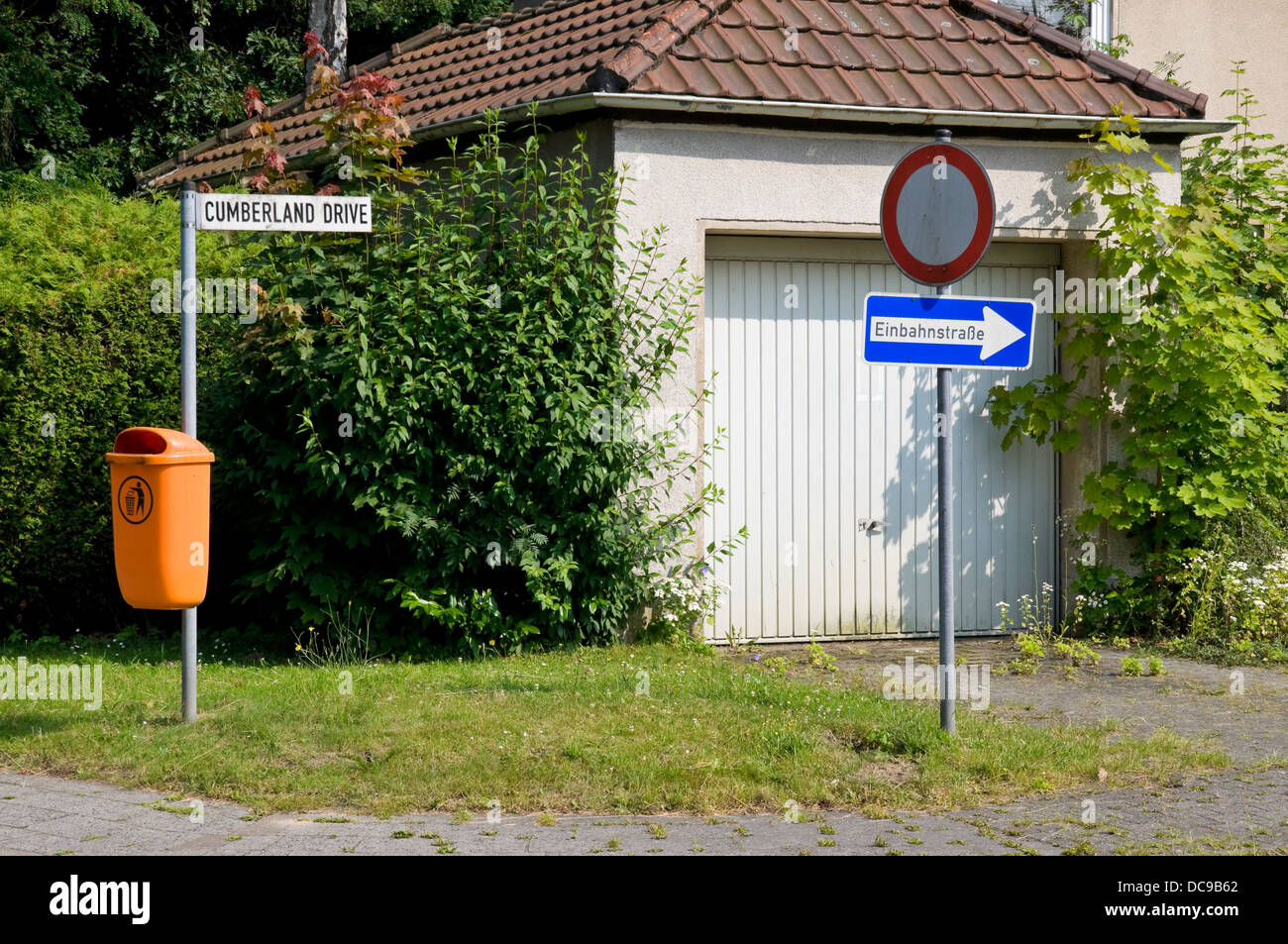 English road name & German one-way-street sign at headquarters of ...