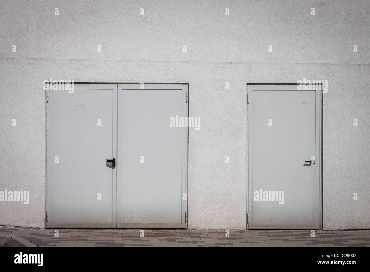 Two external shut doors on a white wall Stock Photo - Alamy