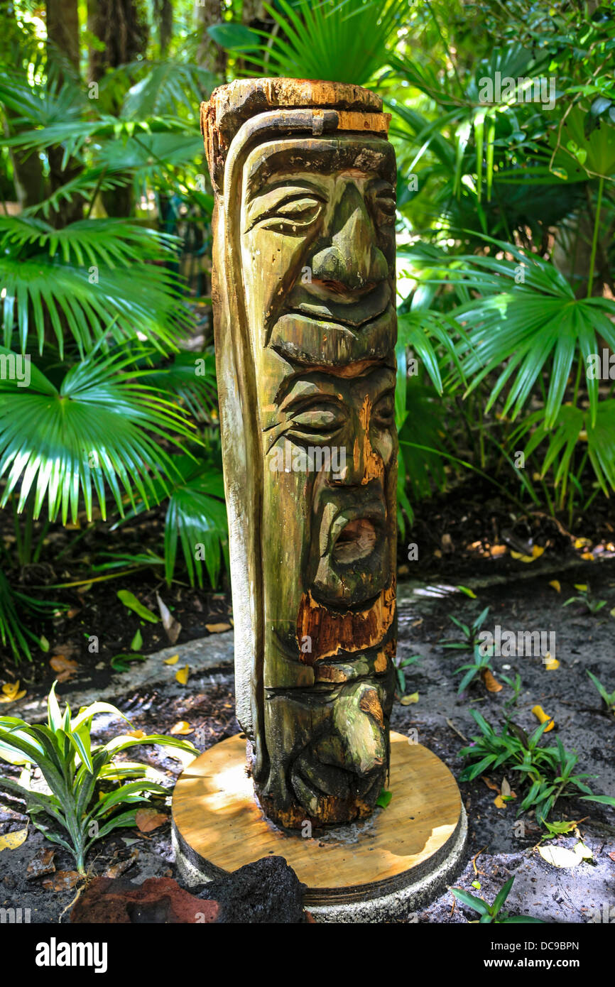 Polynesian Tiki carved wooden carving on display in a jungle garden ...