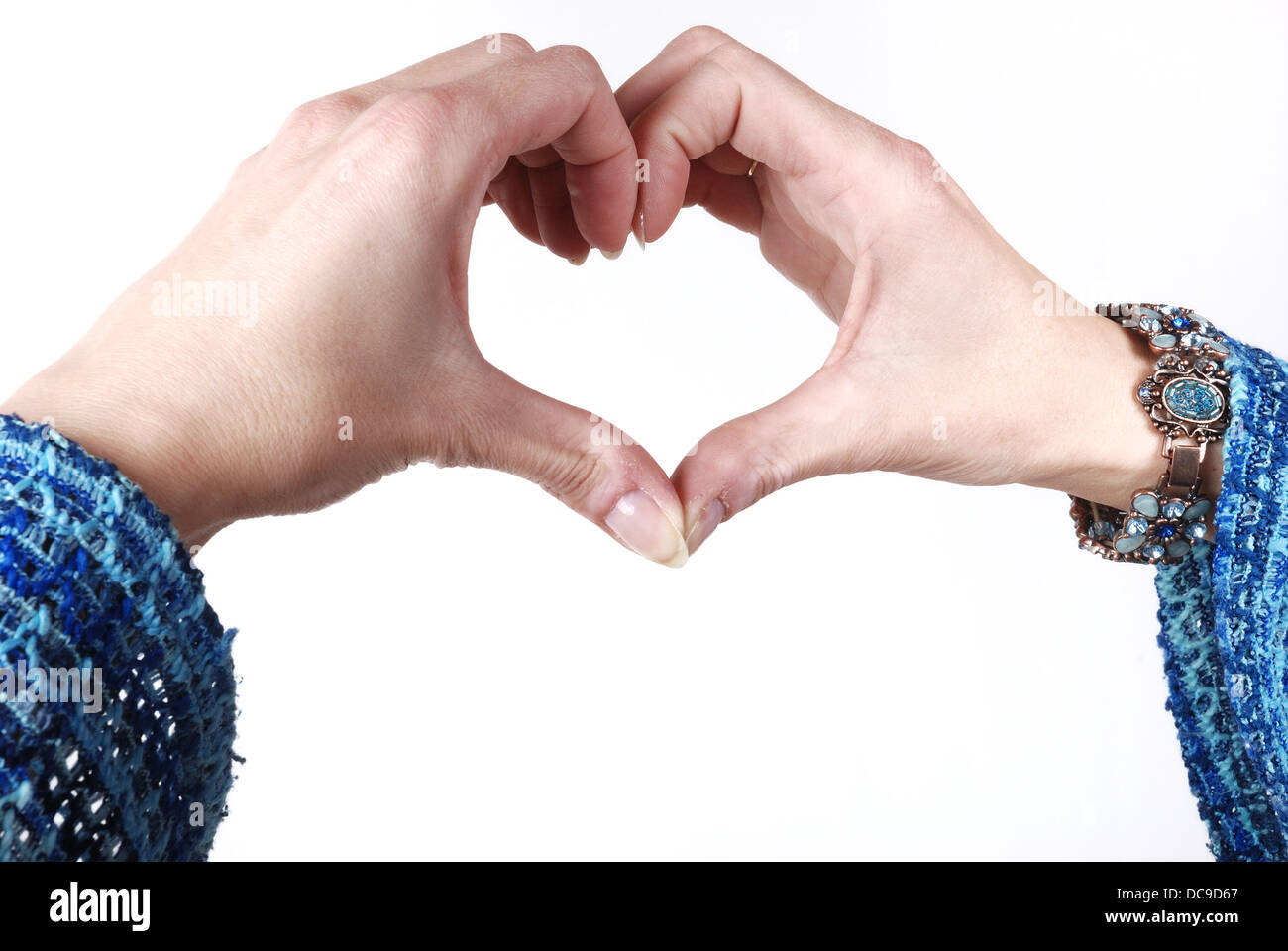 Woman making heart shape with her hands Stock Photo - Alamy