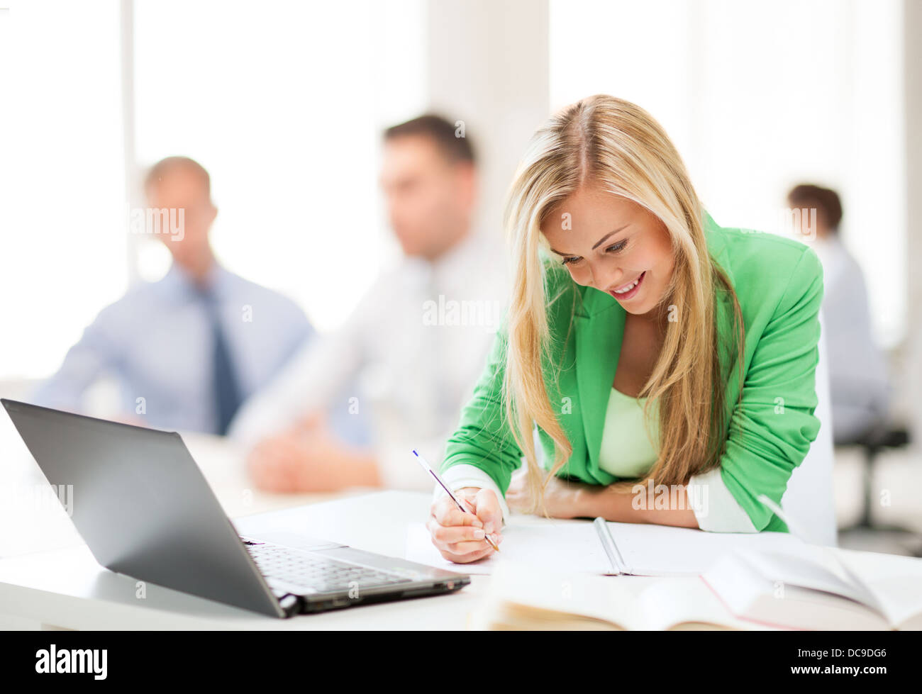 attractive businesswoman taking notes in office Stock Photo - Alamy