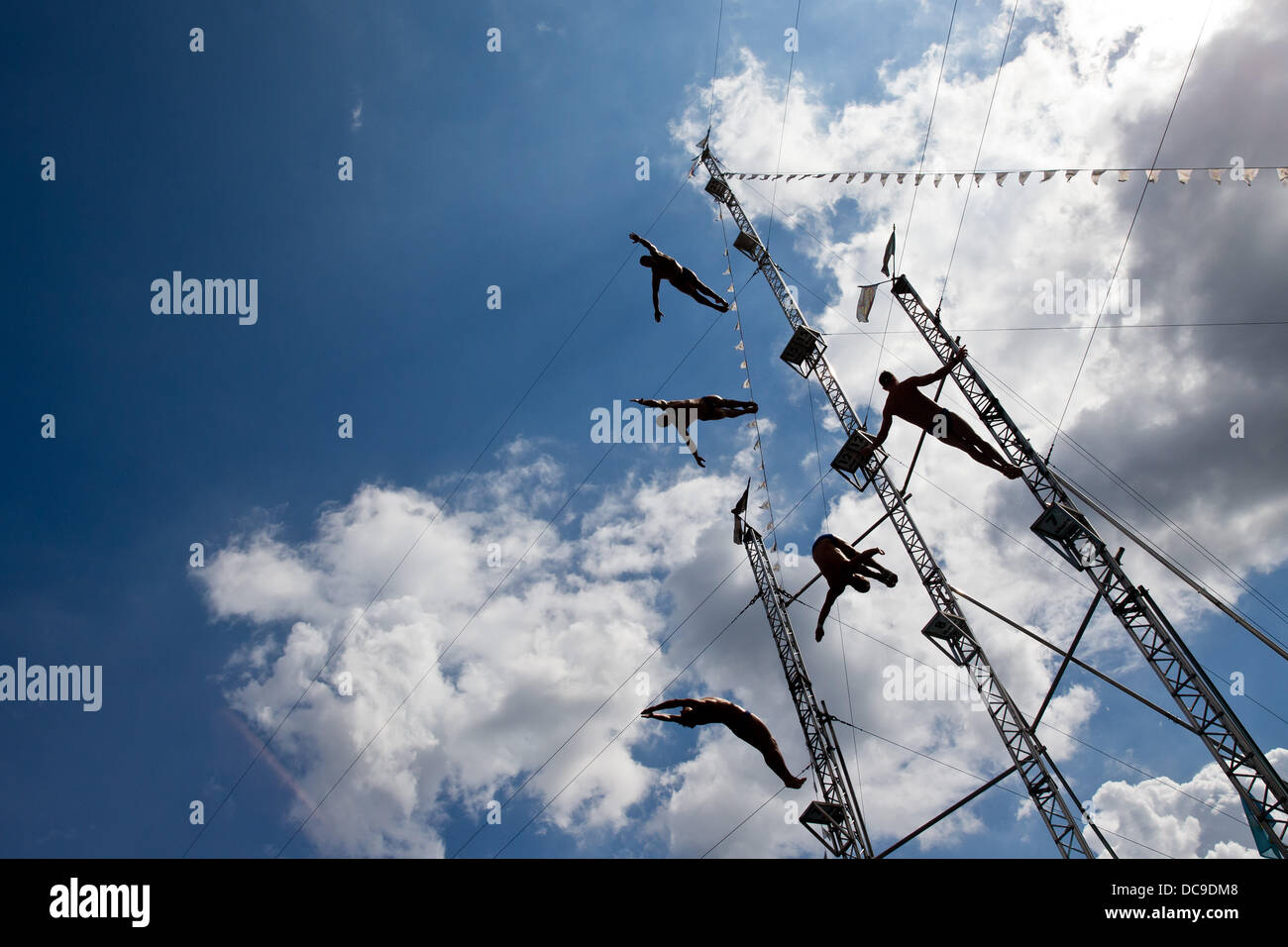 An acrobat jumps into a pool at an amusement park in Geiselwind ...