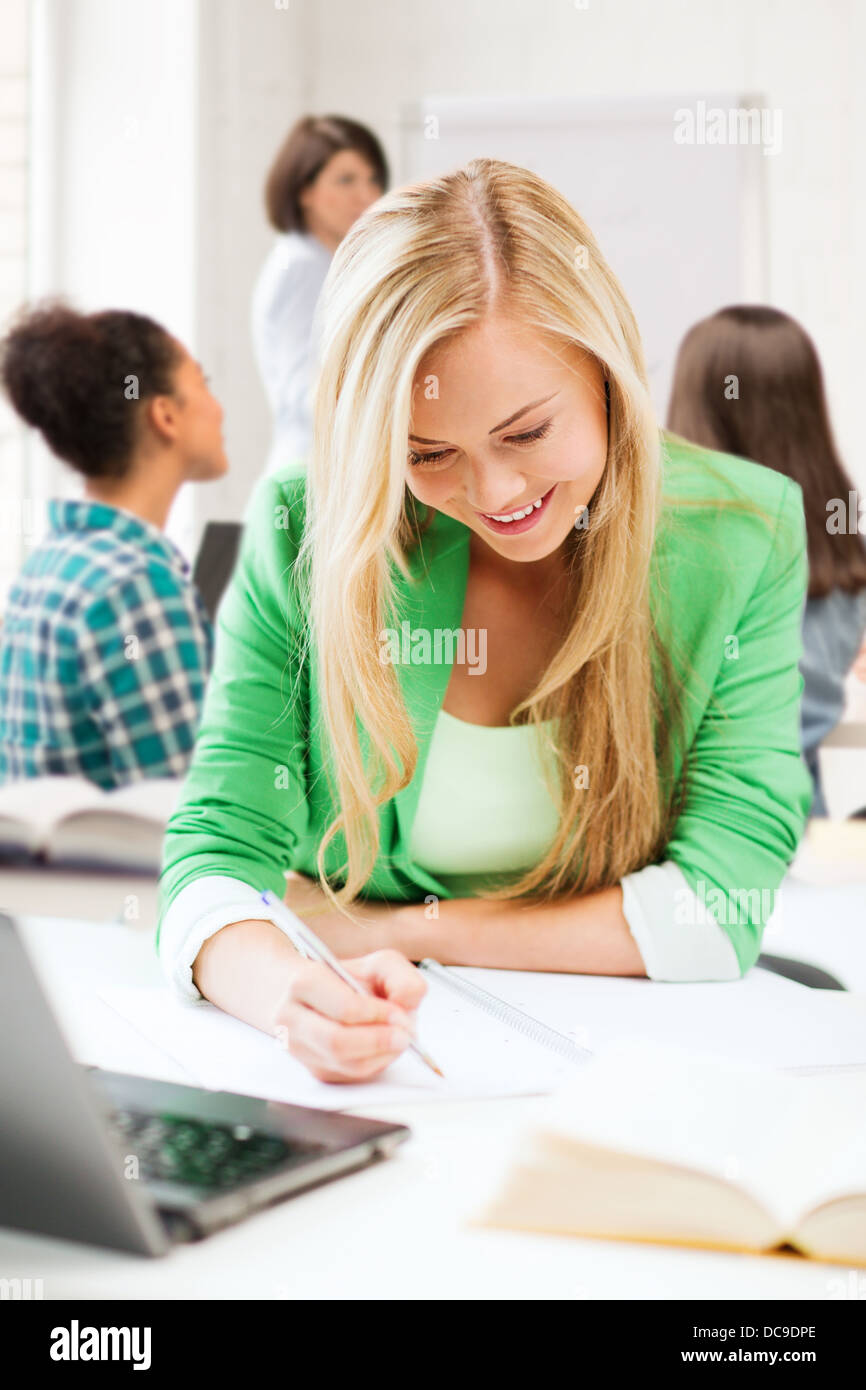 student girl writing in notebook at school Stock Photo - Alamy