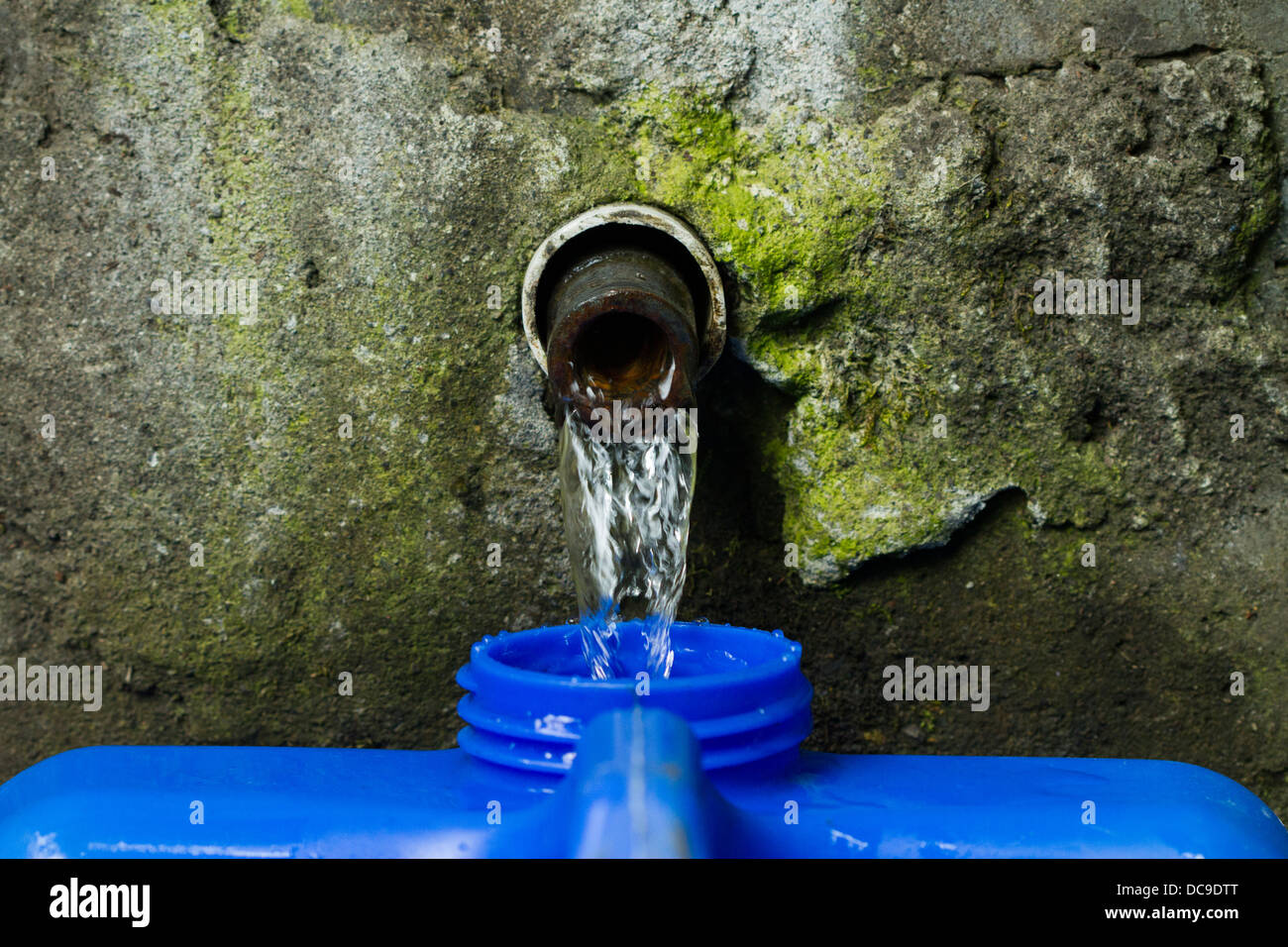 Filling bottles with spring water Stock Photo - Alamy