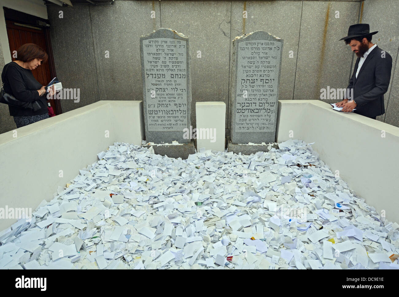 Religious Jewish man and woman praying at The Ohel, the burial place of ...