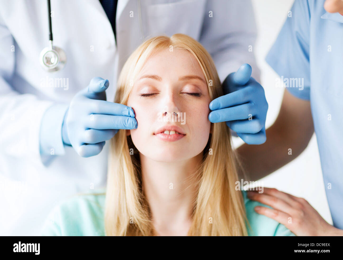 plastic surgeon and nurse with patient Stock Photo - Alamy