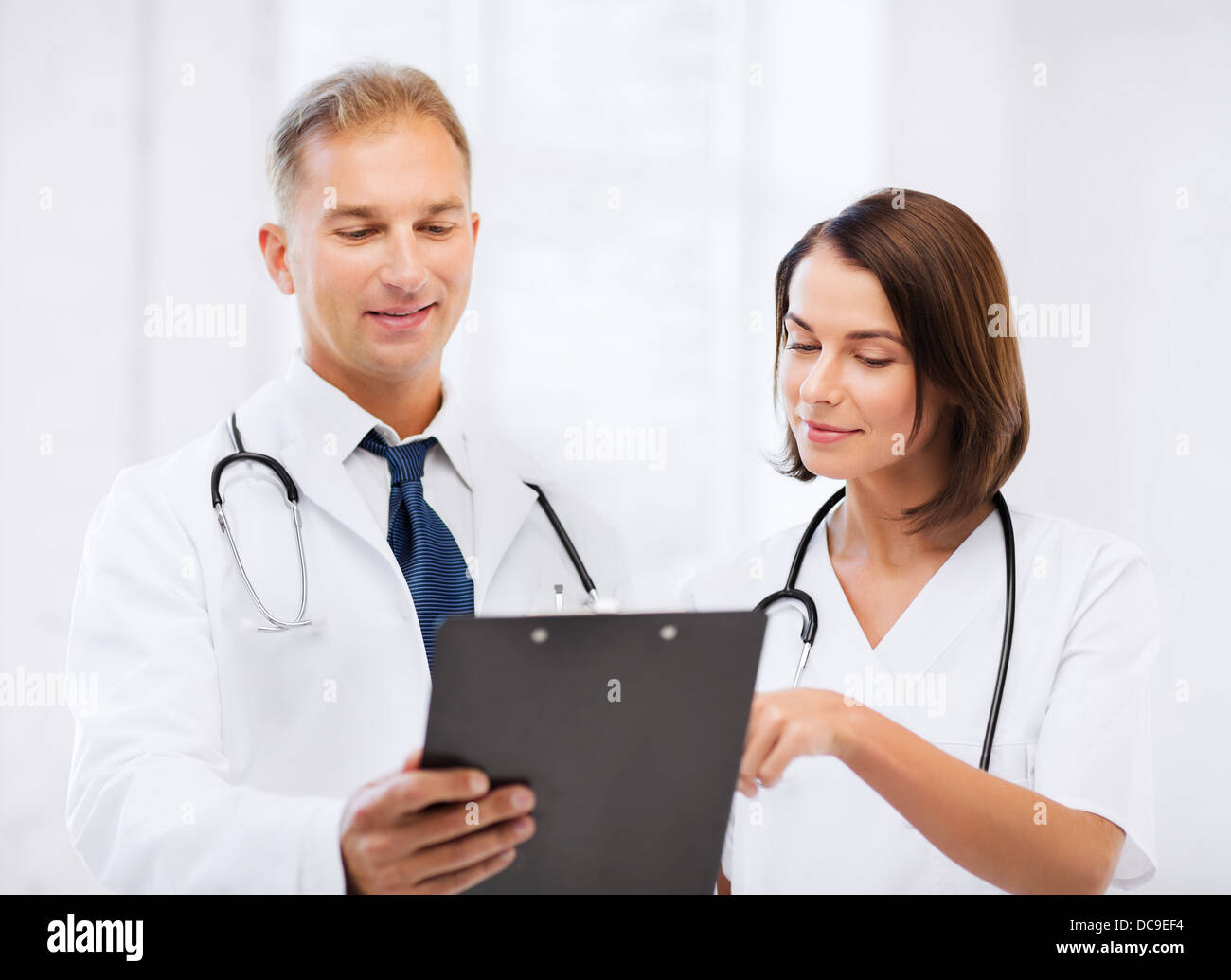 two doctors writing prescription Stock Photo - Alamy