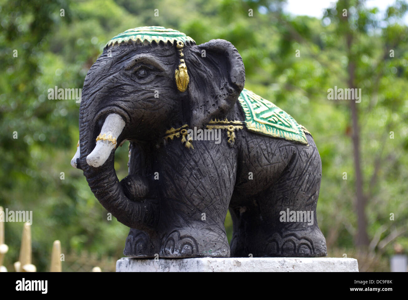 Cute Elephant statue on fence post in Thailand Stock Photo - Alamy