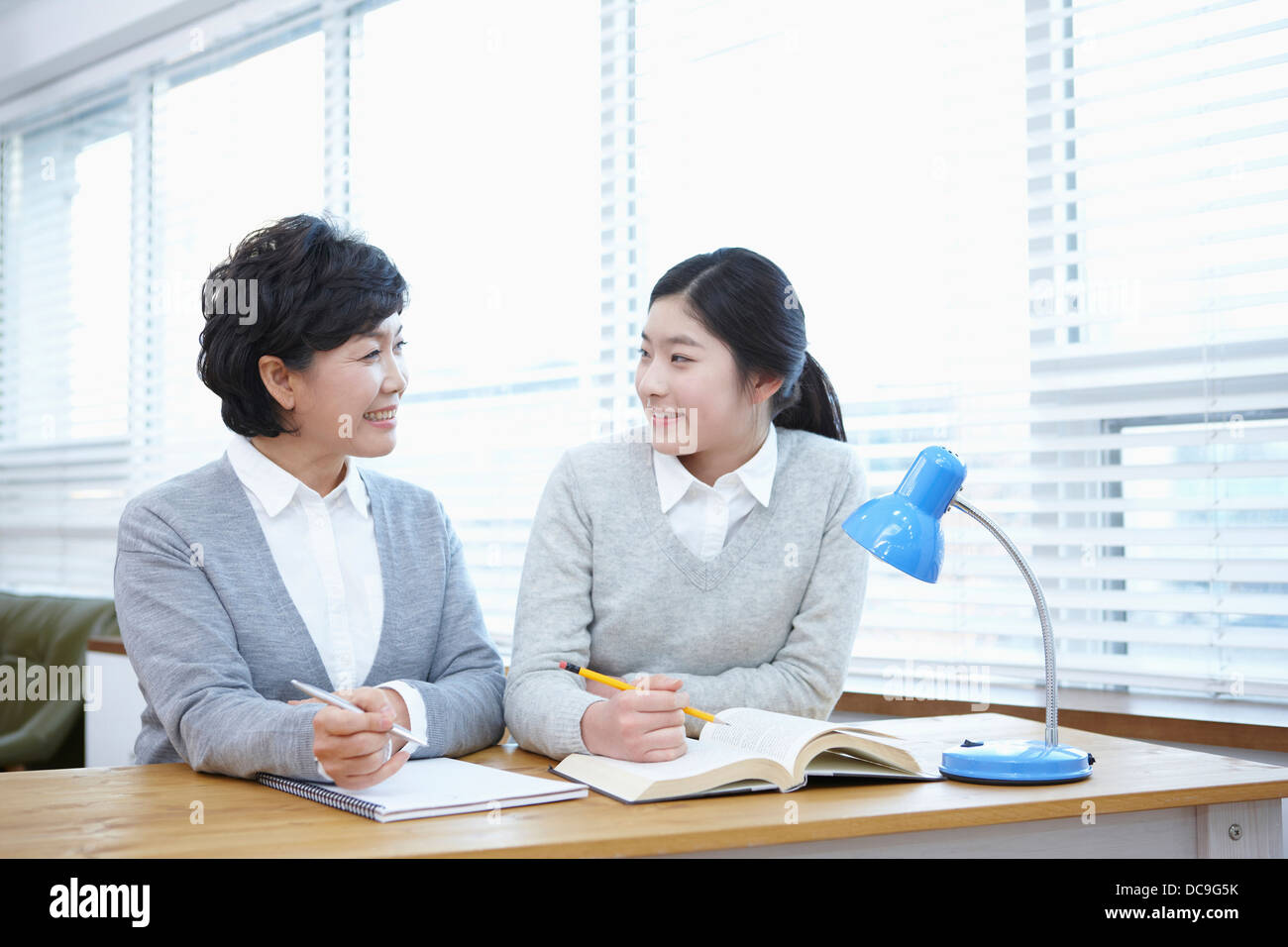 mother and daughter sitting together in the classroom Stock Photo - Alamy