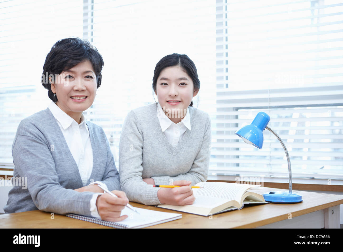 mother and daughter sitting together in the classroom Stock Photo - Alamy