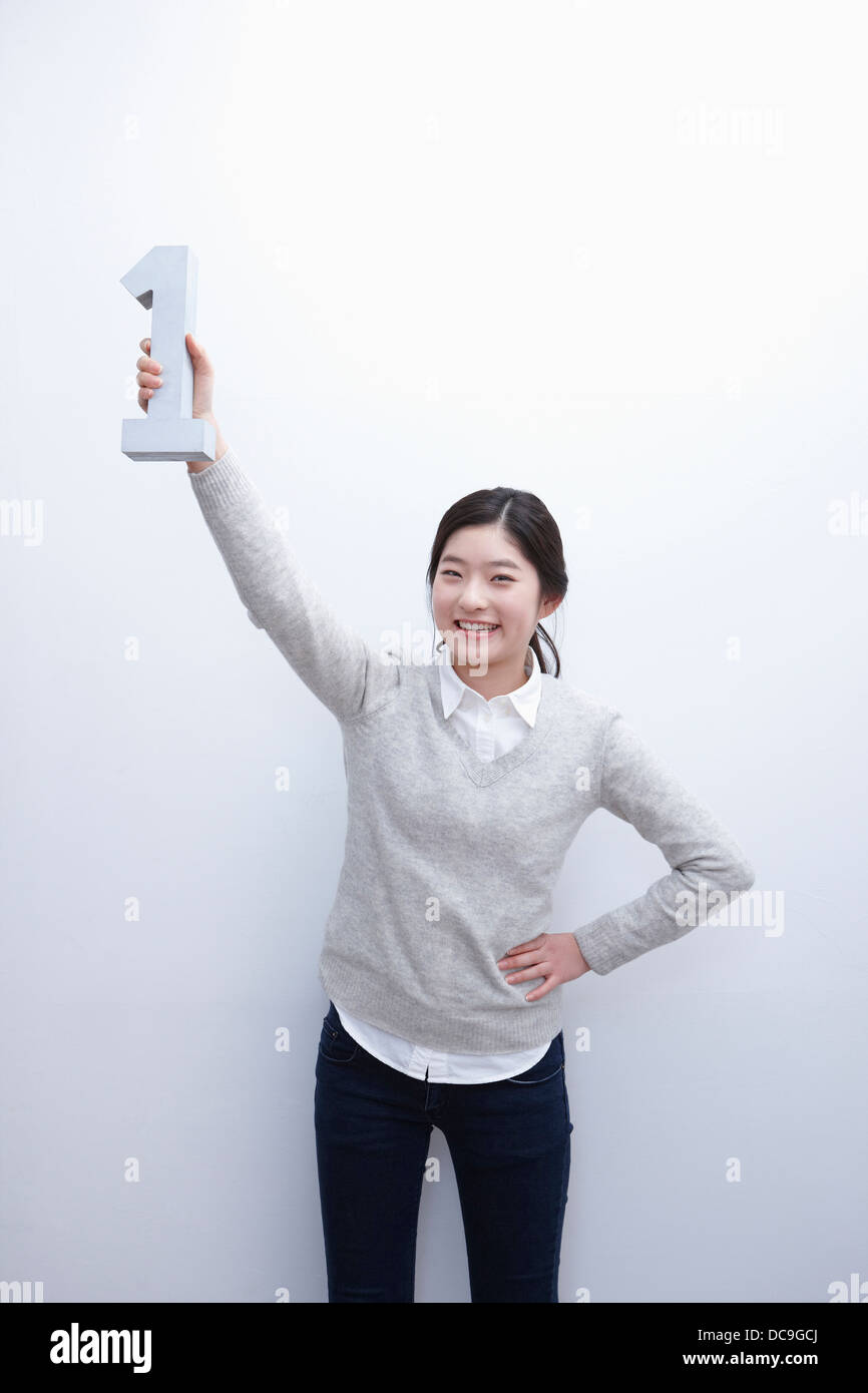 a student holding number one block Stock Photo - Alamy