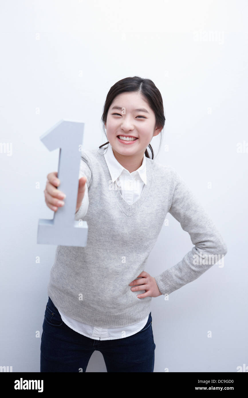 a student holding number one block Stock Photo - Alamy