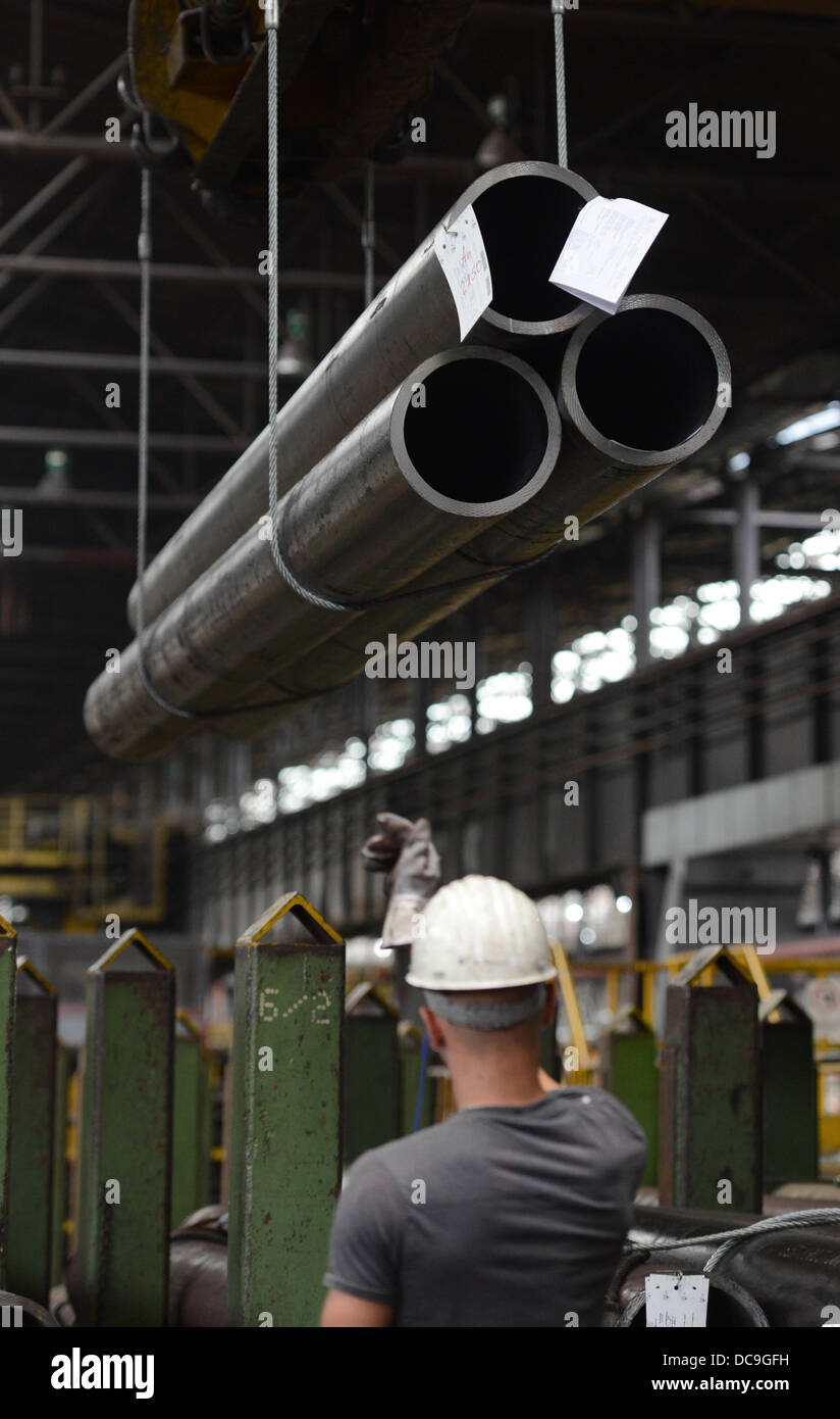 An employee loads steel pipes in the manufacturing hall at Vallourec ...