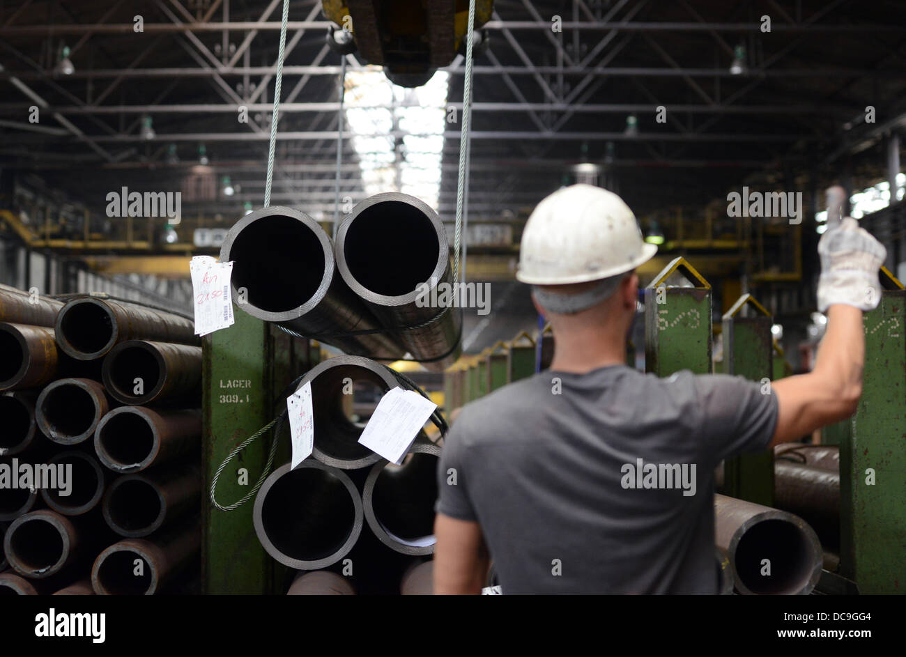 An employee loads steel pipes in the manufacturing hall at Vallourec ...