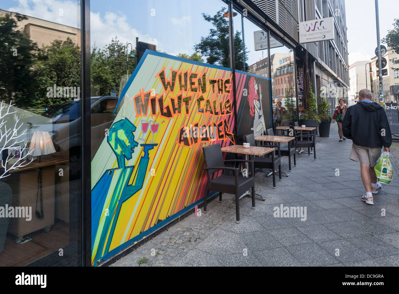 Old man walking past a colourful window of a bar in Berlin Stock Photo ...