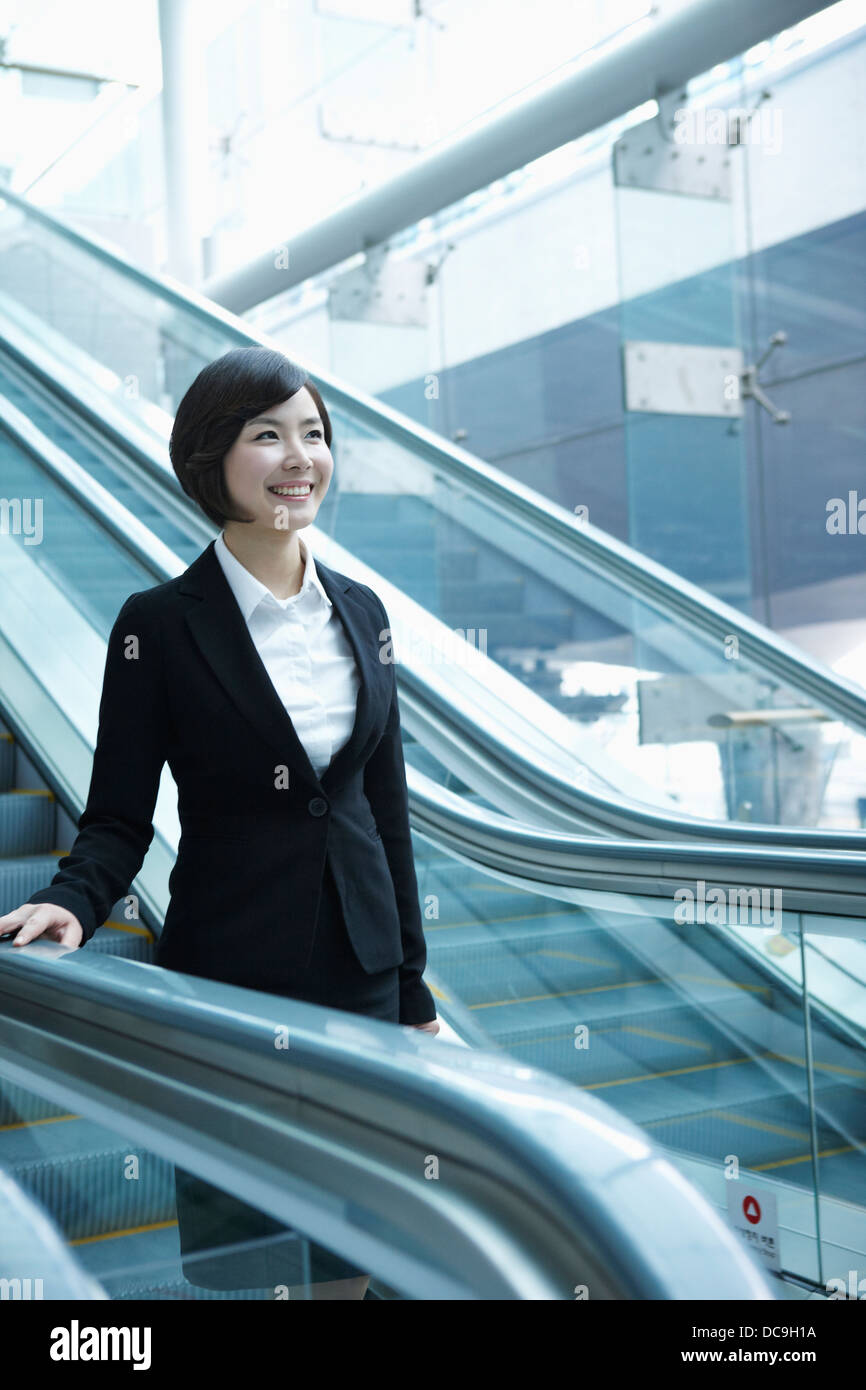 Woman taking escalator hi-res stock photography and images - Alamy