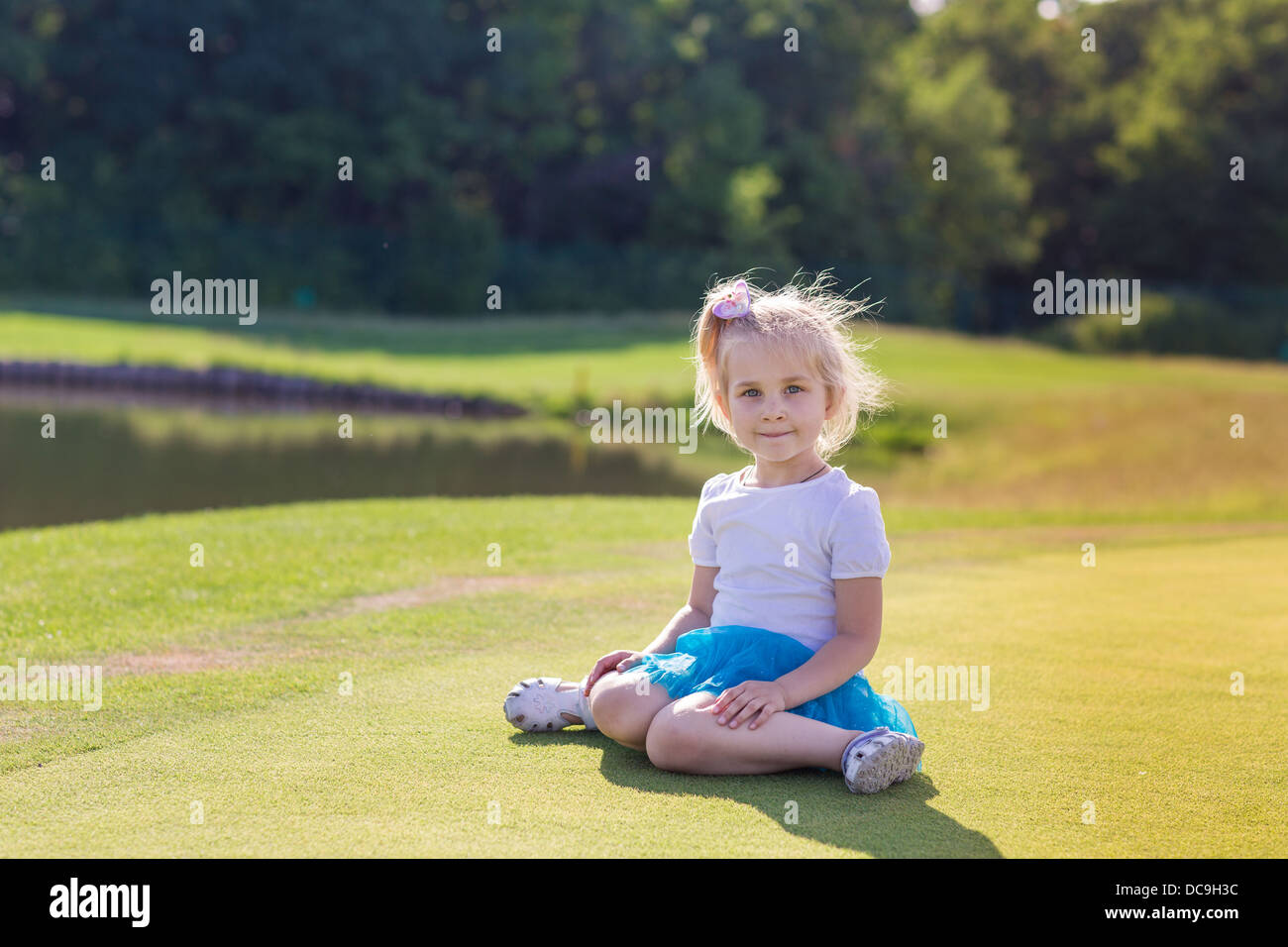 Cute little girl playing golf on a field outdoor Stock Photo - Alamy