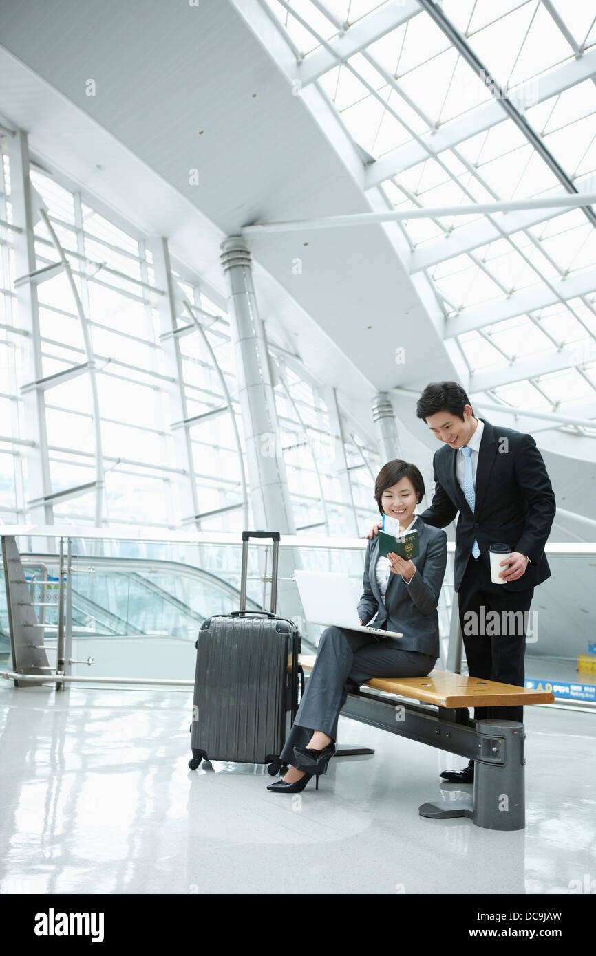 a businessman helping businesswoman with the boarding pass Stock Photo ...