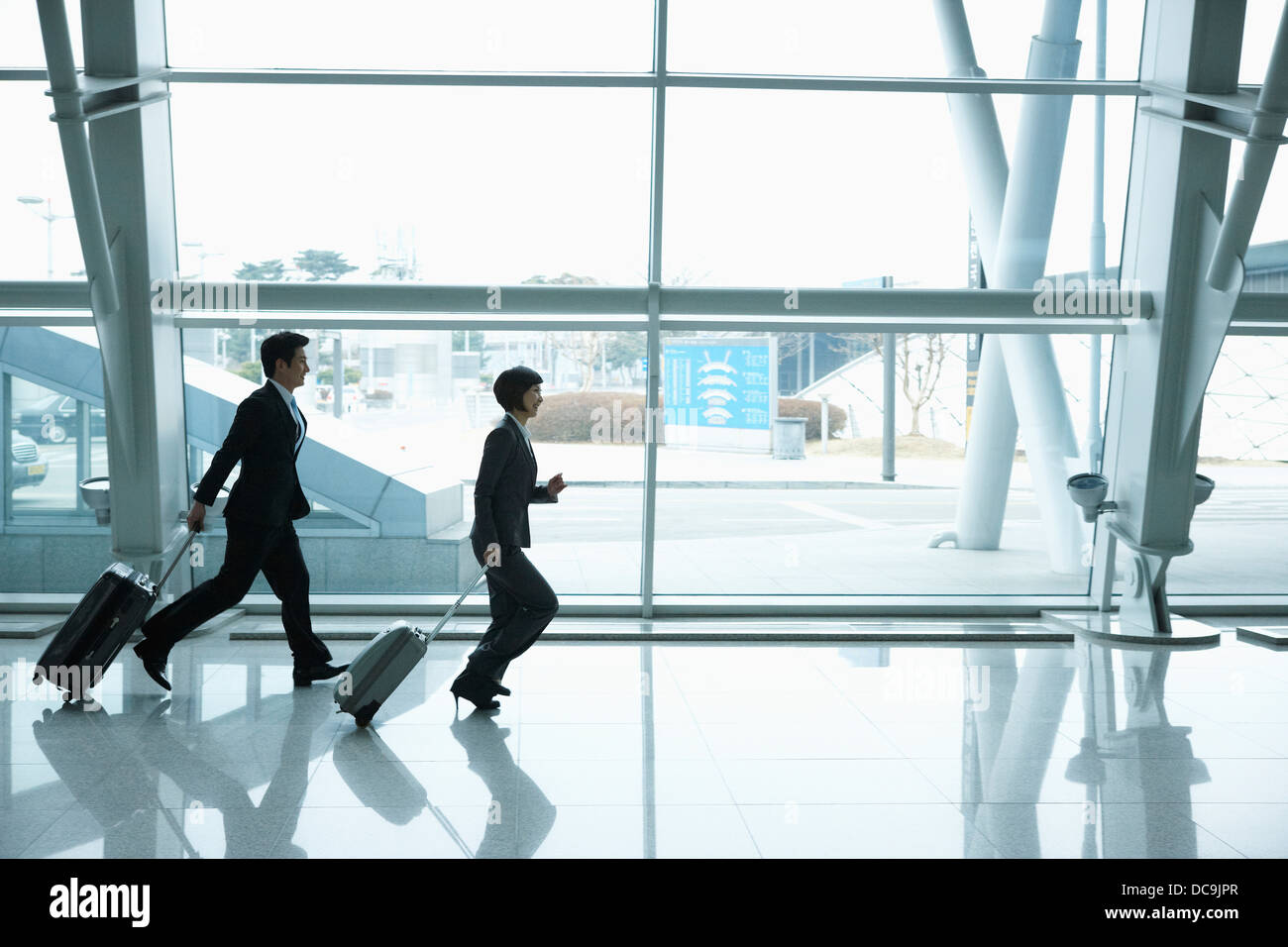 Woman airport baggage running hi-res stock photography and images - Alamy
