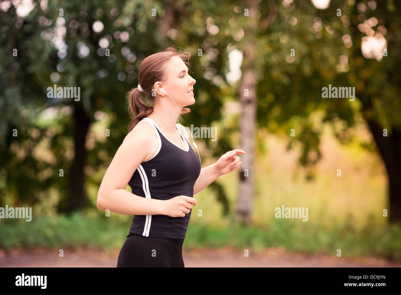 Beautiful fit runner woman jogging in nature outdoor Stock Photo - Alamy
