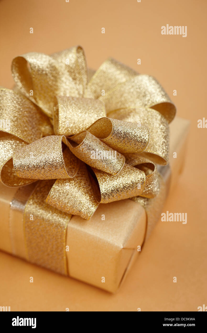 graceful orange gift box with golden ribbon Stock Photo - Alamy
