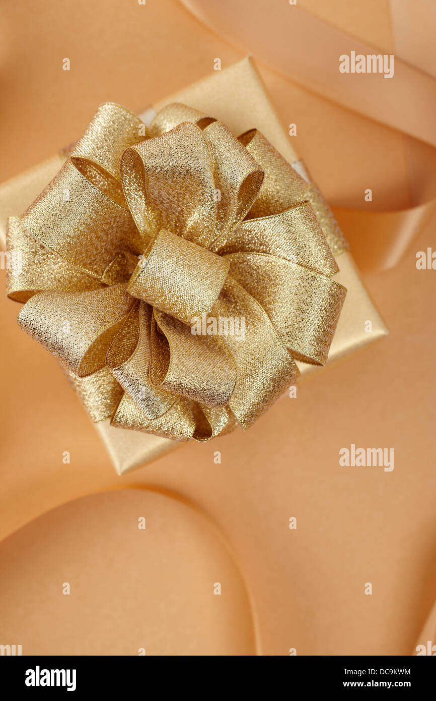 graceful orange gift box with golden ribbon Stock Photo - Alamy