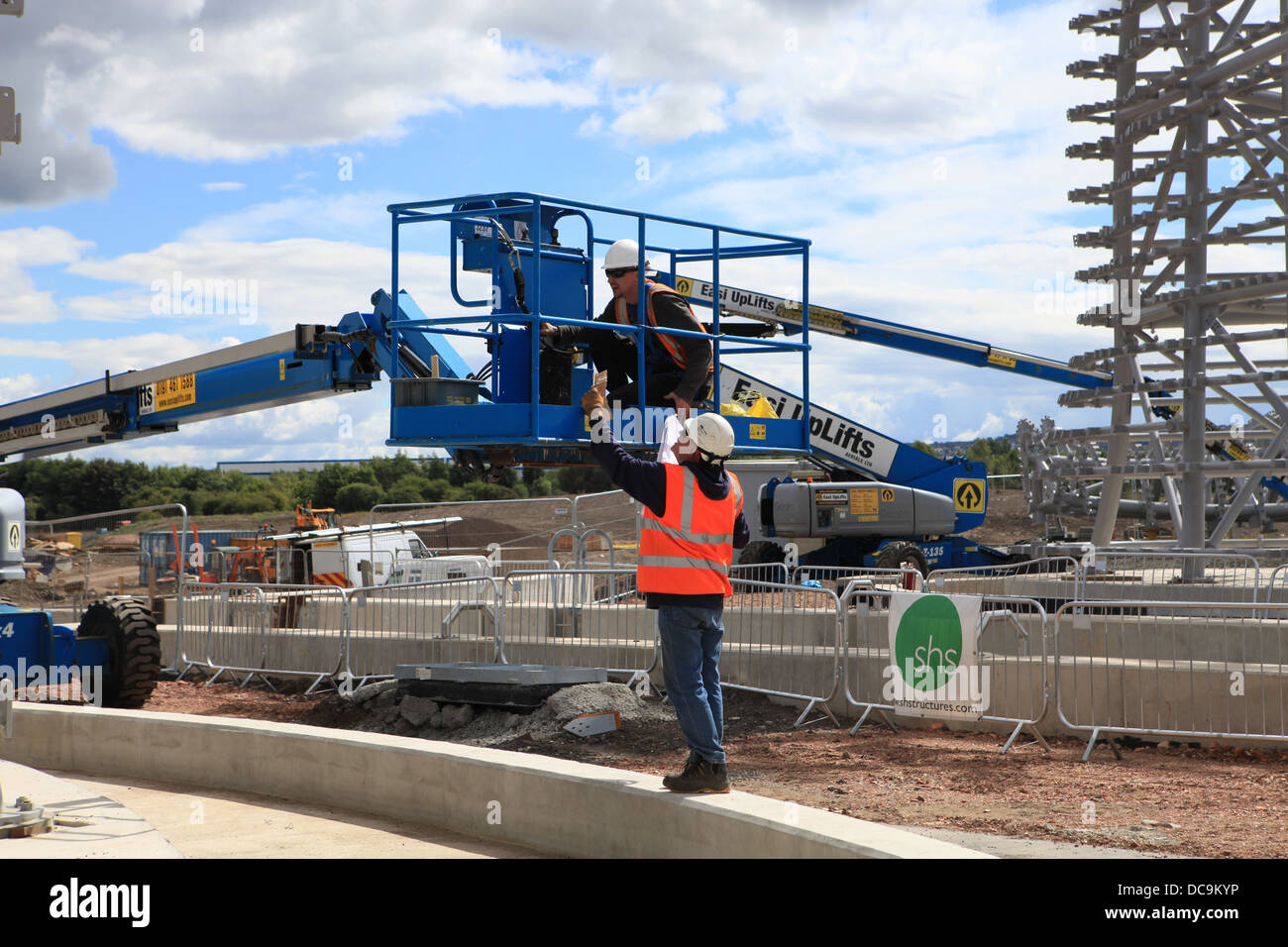 2 construction workers discussing operations on site Stock Photo - Alamy