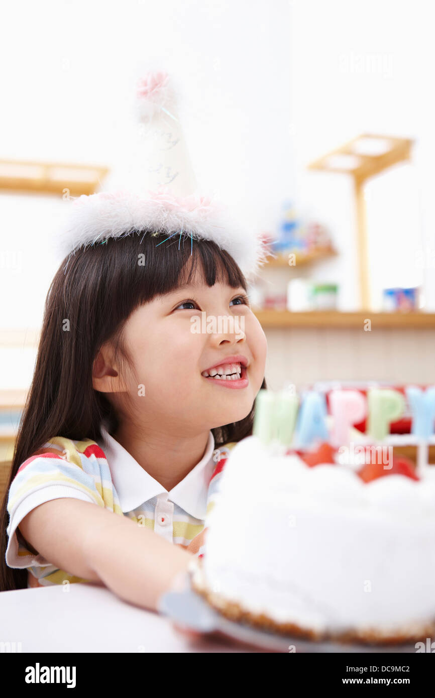 a kid giving someone a birthday cake Stock Photo - Alamy