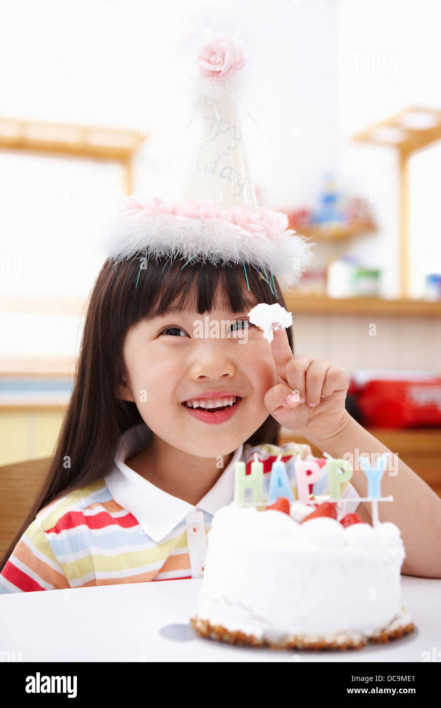 a kid playing with a birthday cake Stock Photo - Alamy