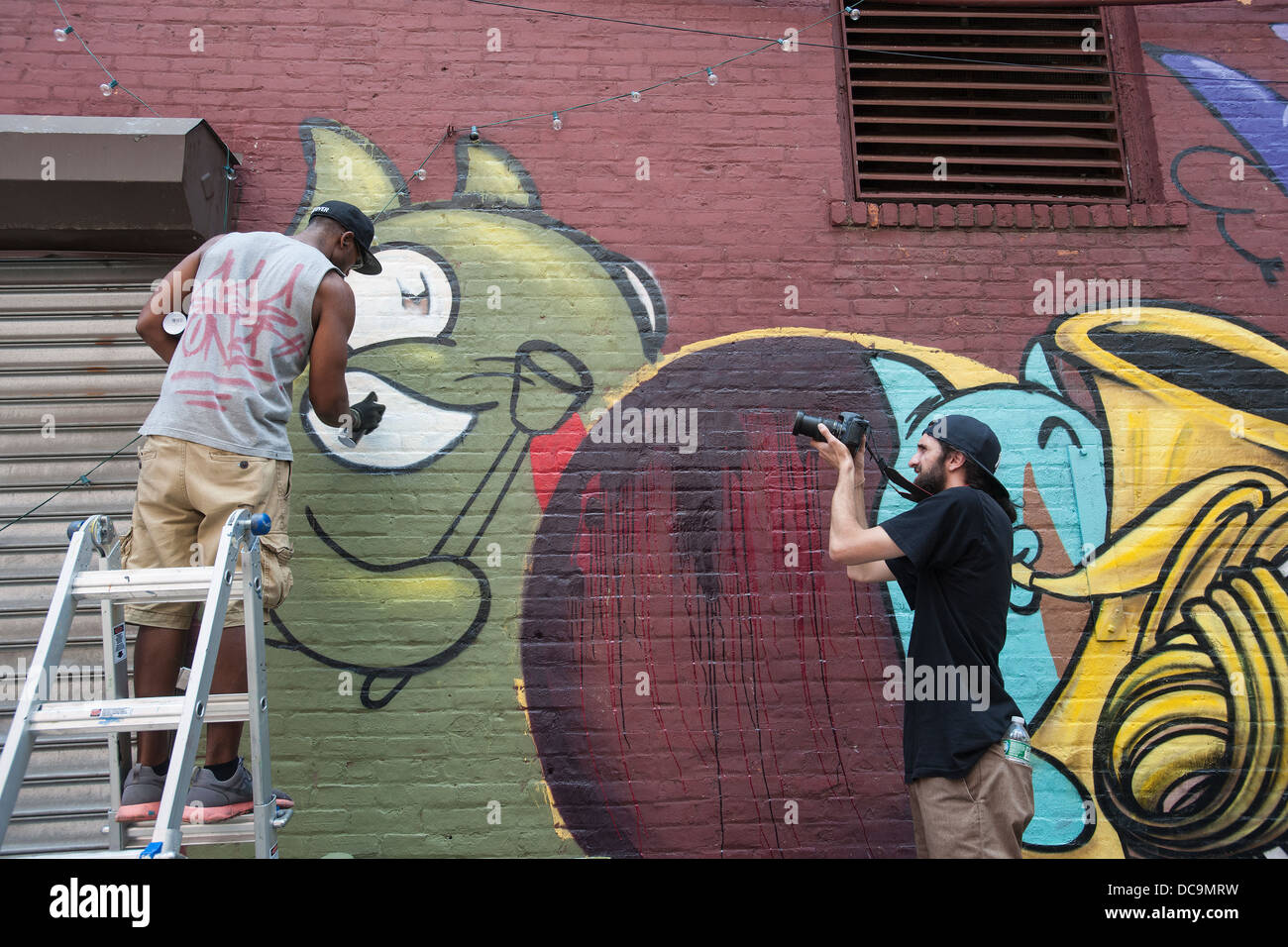 See One paints the "Follow the BEAT" street art mural on a wall in ...
